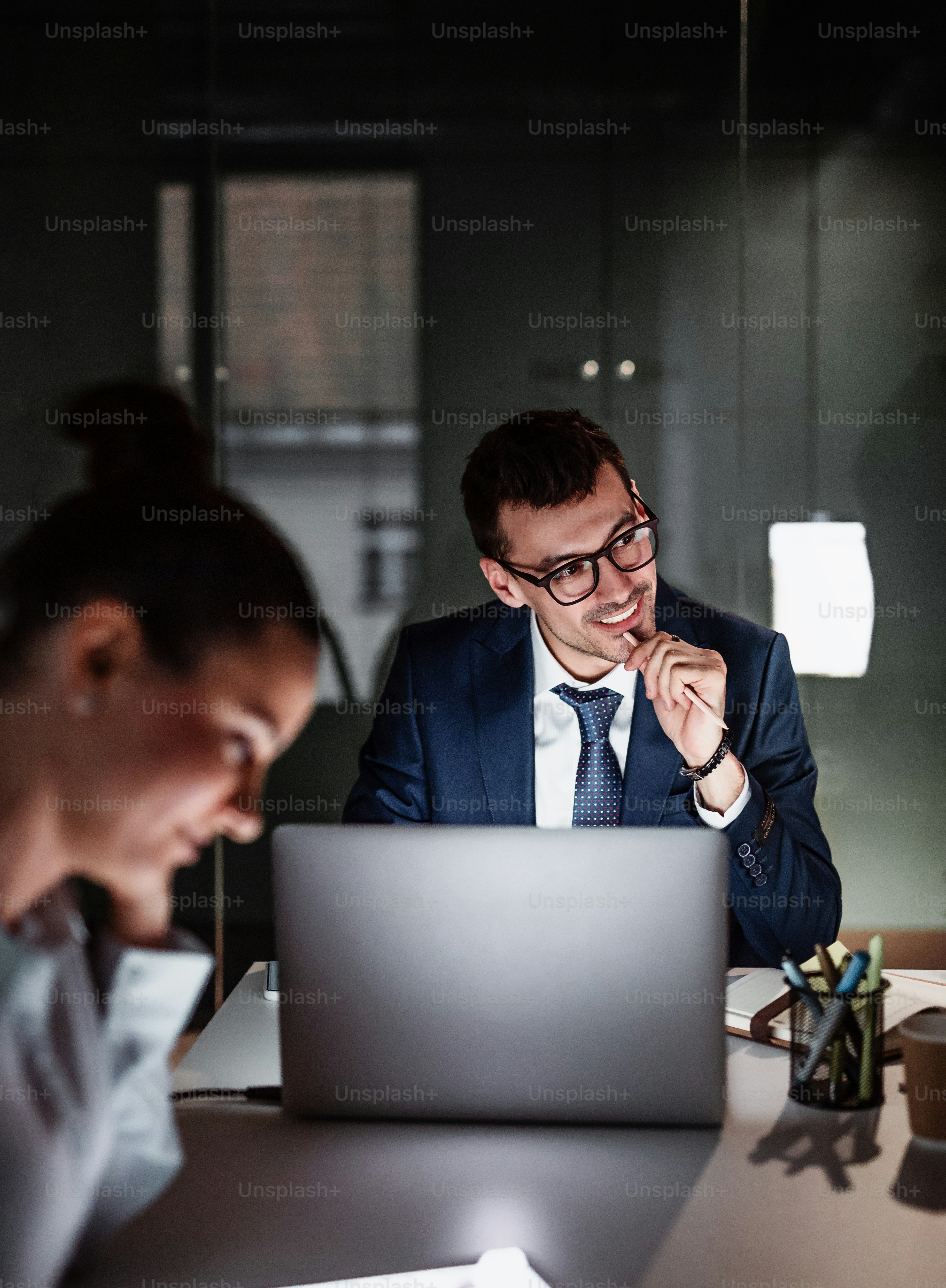 A portrait of happy young businessman with computer in an office ...