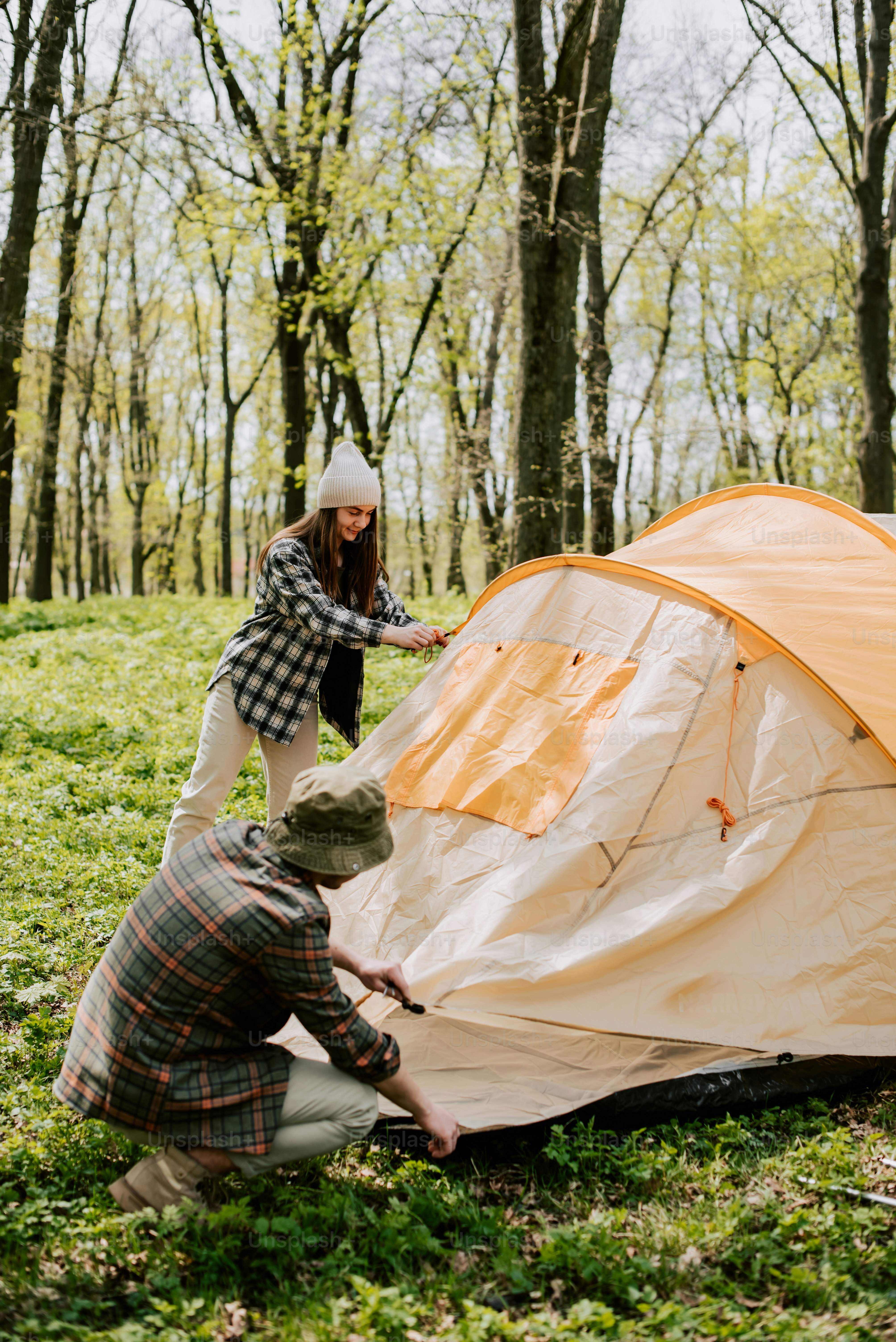 A couple of people sitting next to a tent photo – Campground Image on ...