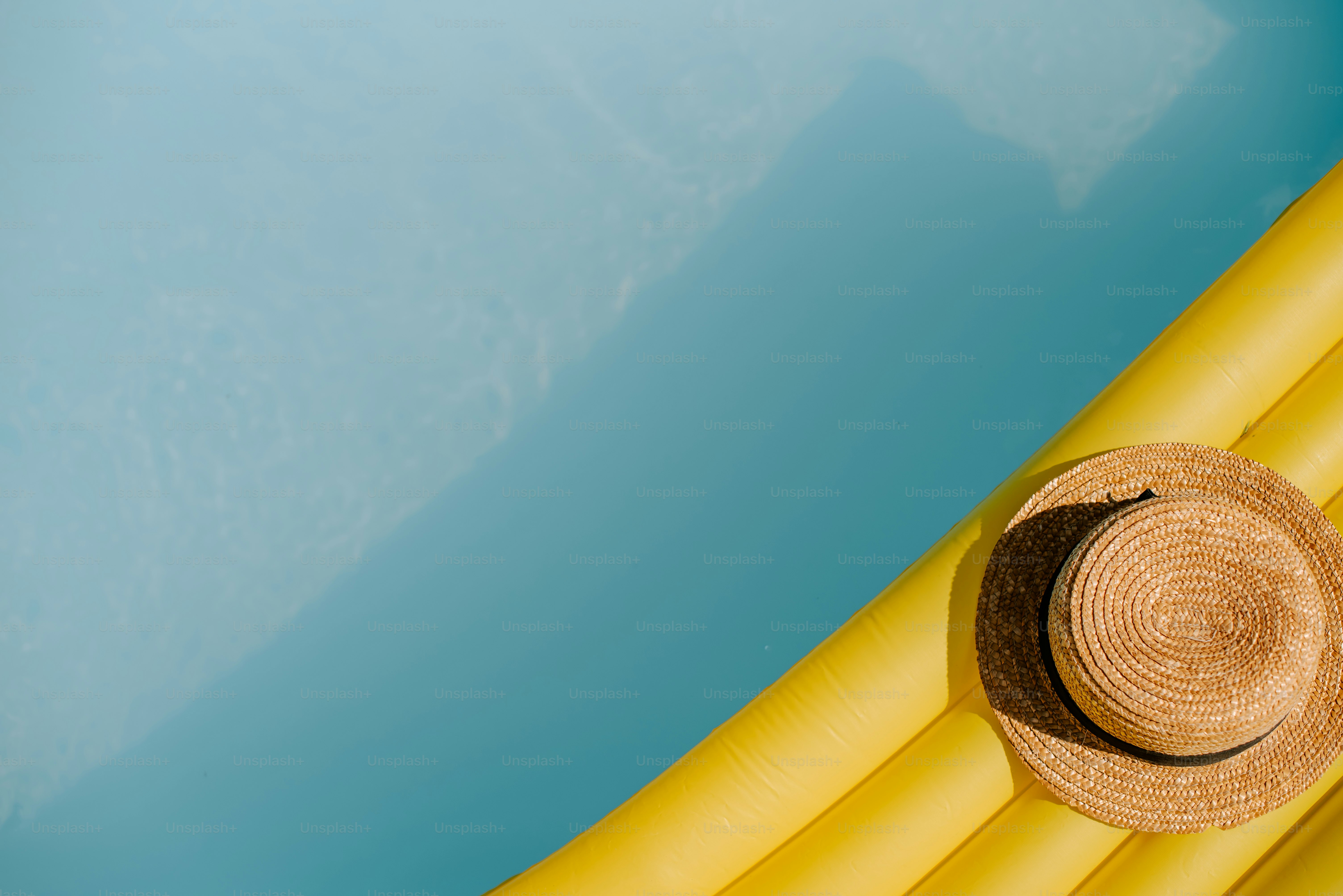 A straw hat on a raft floating in a pool photo – Wallpaper Image on ...