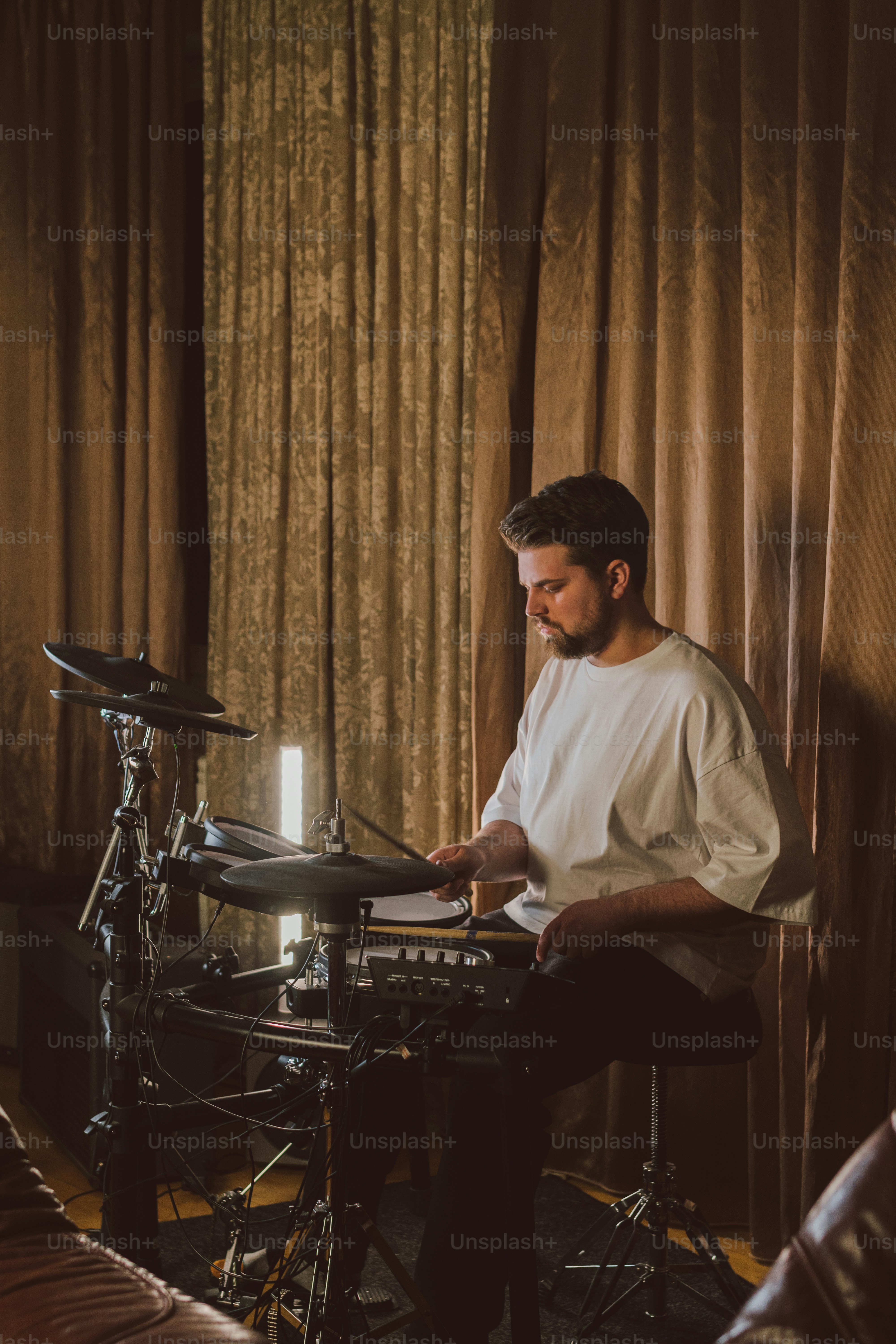 A man sitting in front of a drum set photo – Music Image on Unsplash