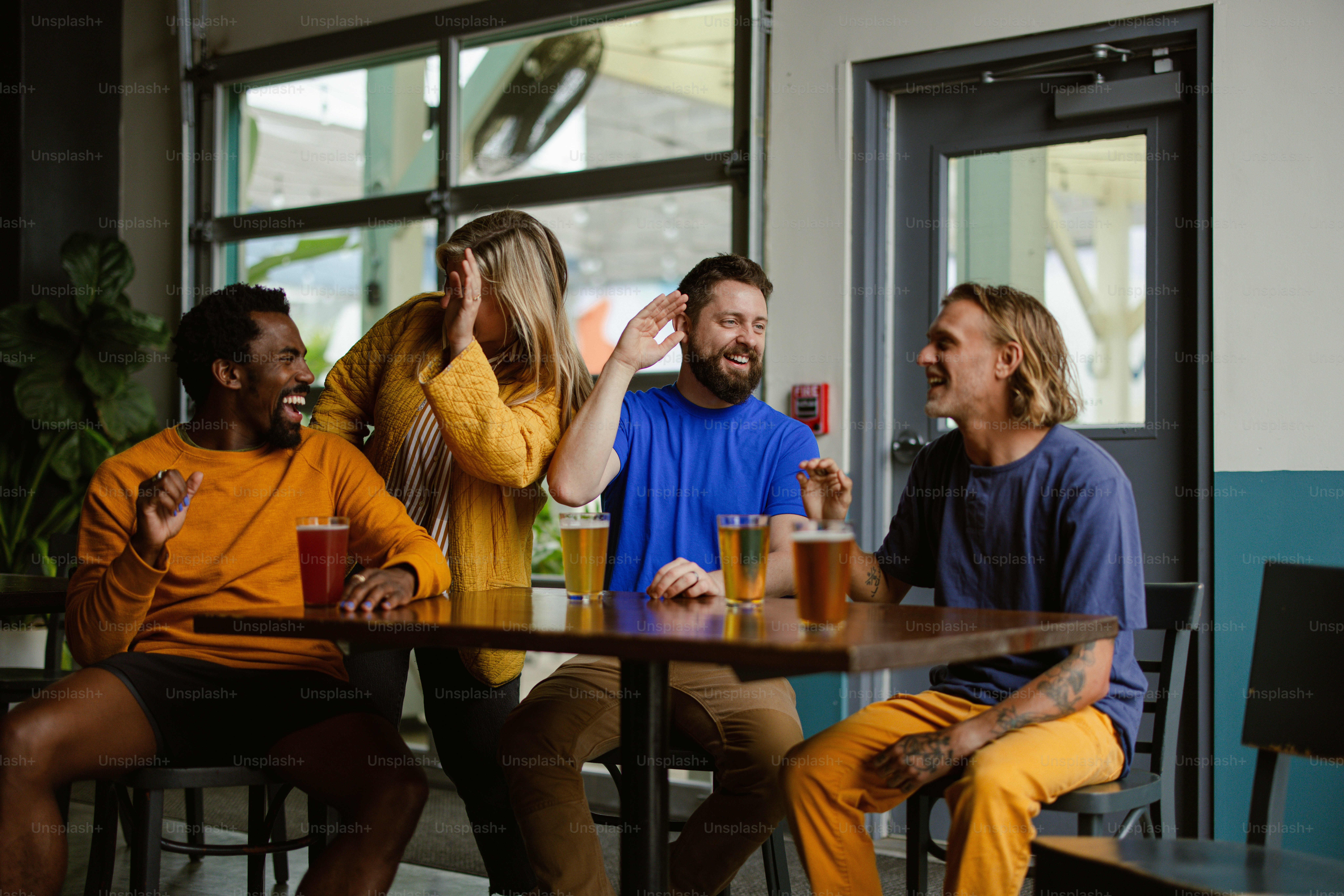 A group of people sitting around a table photo – Crowd Image on Unsplash