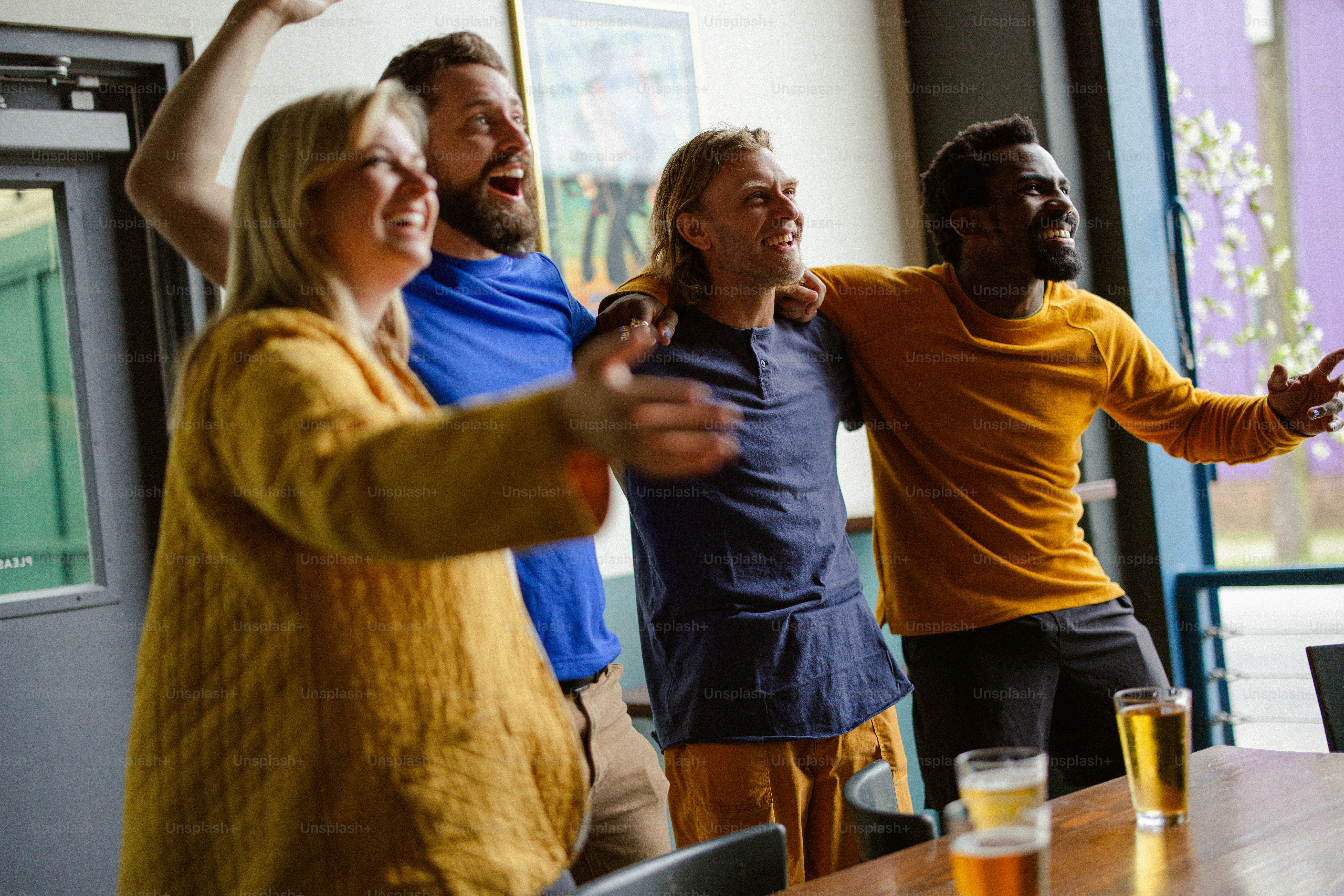 A group of people standing around a wooden table photo – Crowd Image on ...