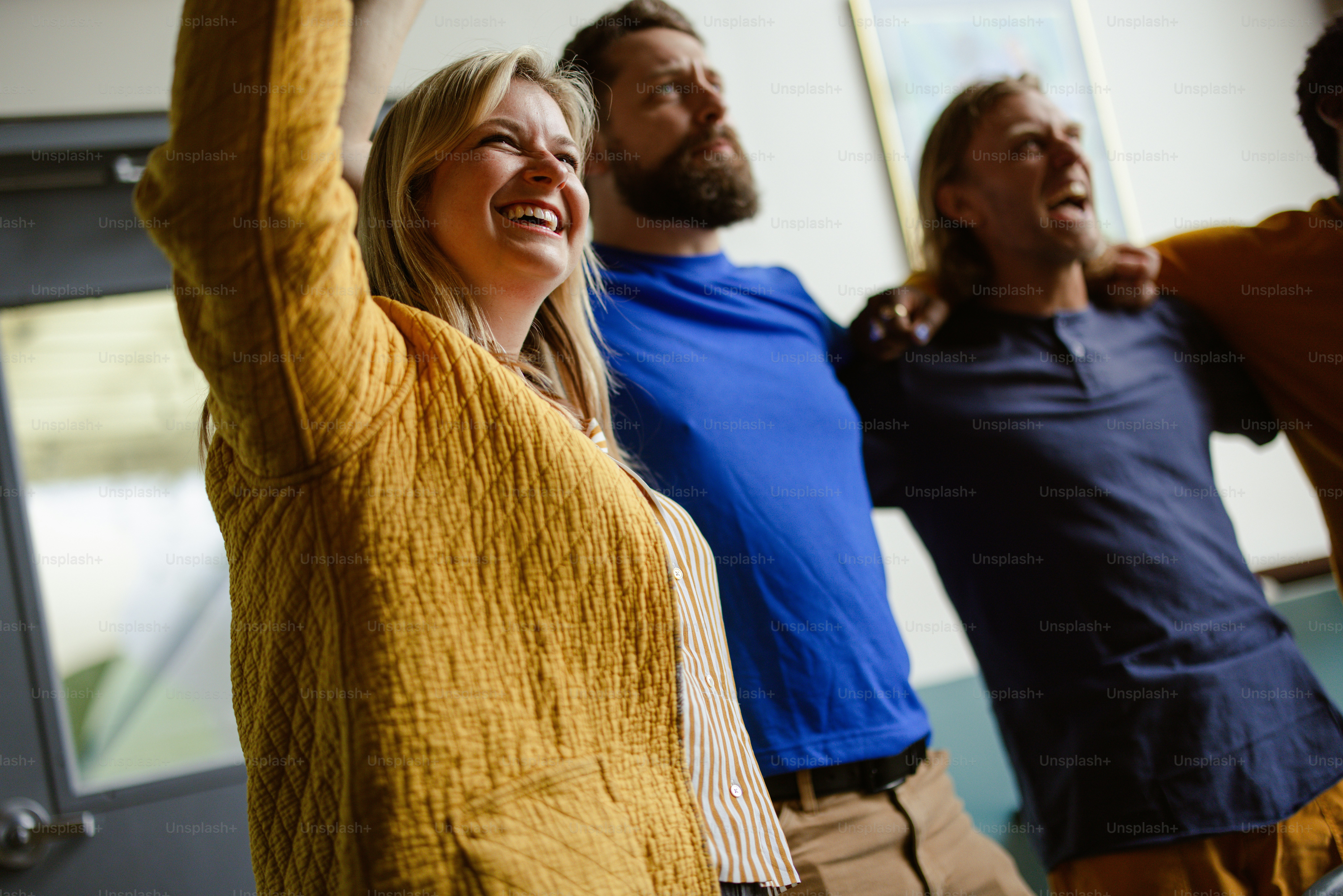 A group of people standing around a wooden table photo – Crowd Image on ...