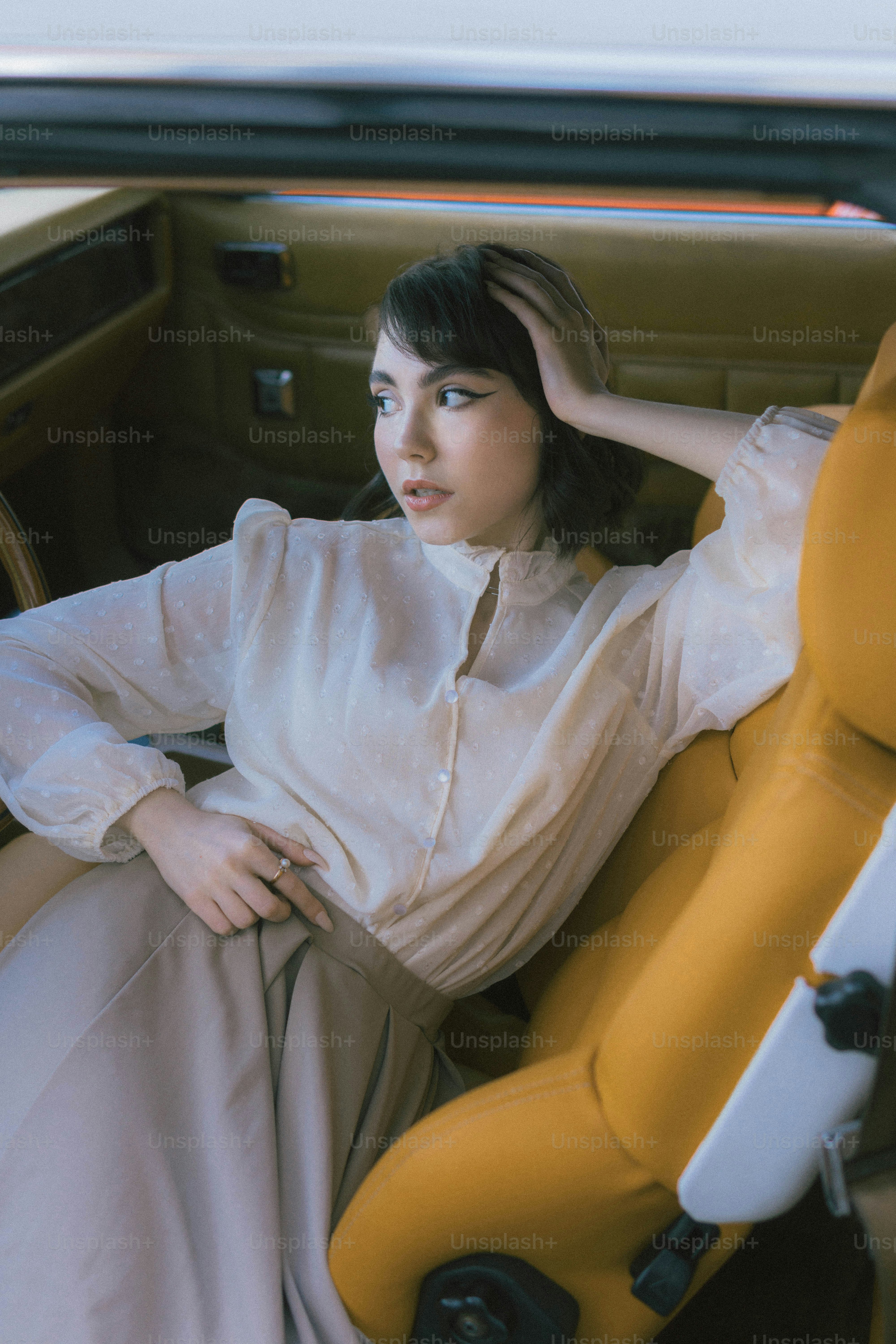 A woman sitting in the back of a car photo – Luxury Image on Unsplash