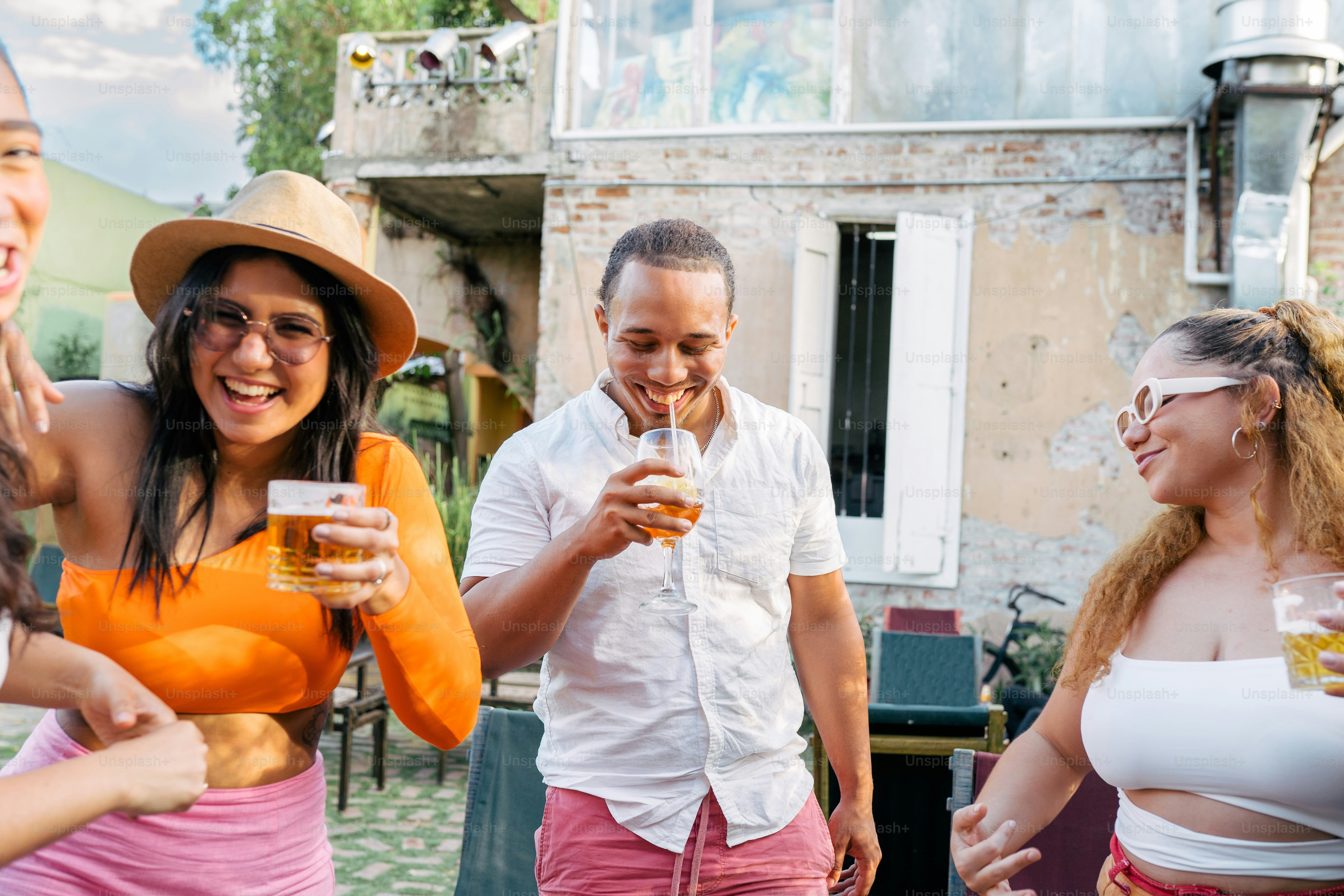 A group of people standing around a wooden table photo – Backyard party ...