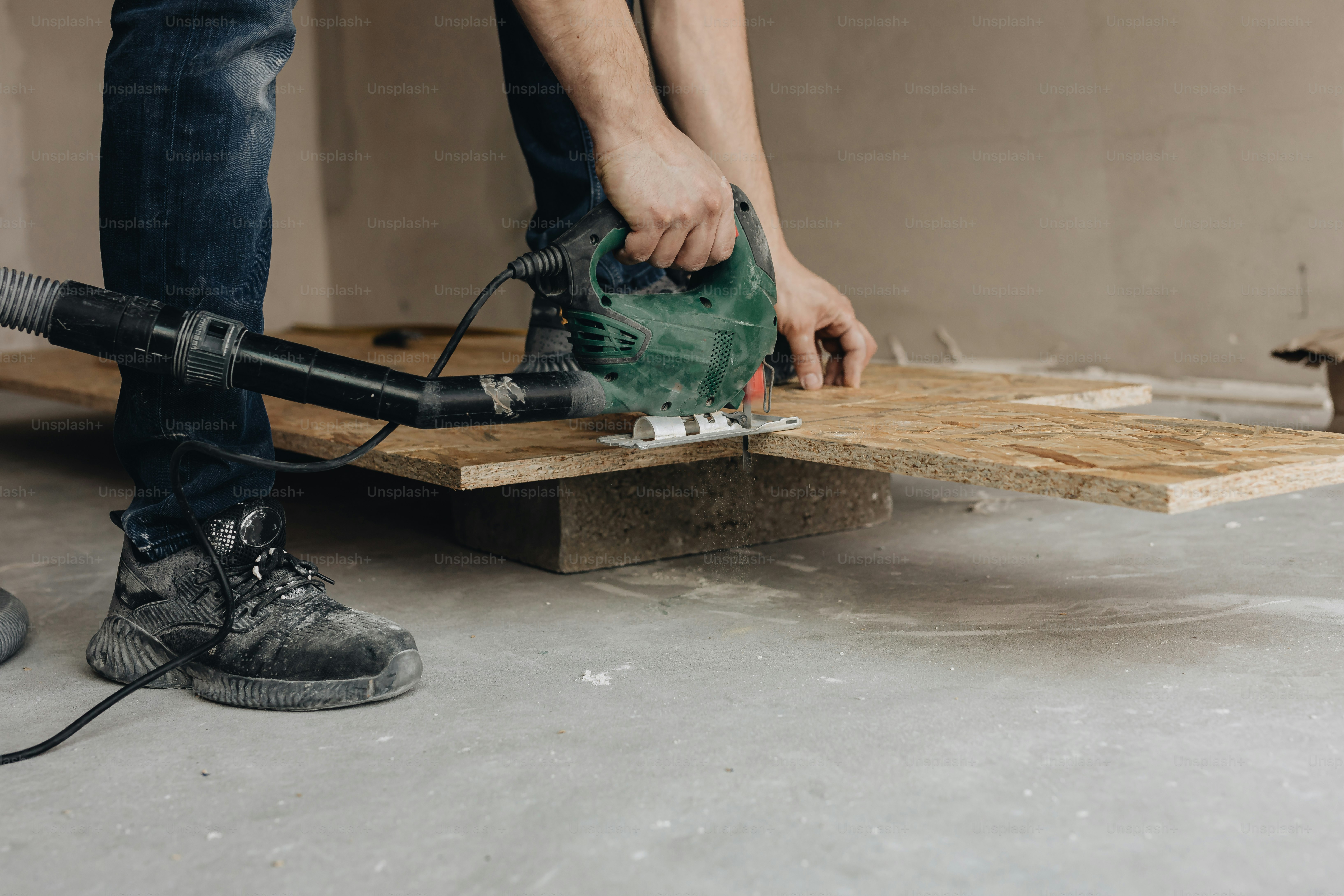 A man sanding a floor with a sanding machine photo – Construction Image ...