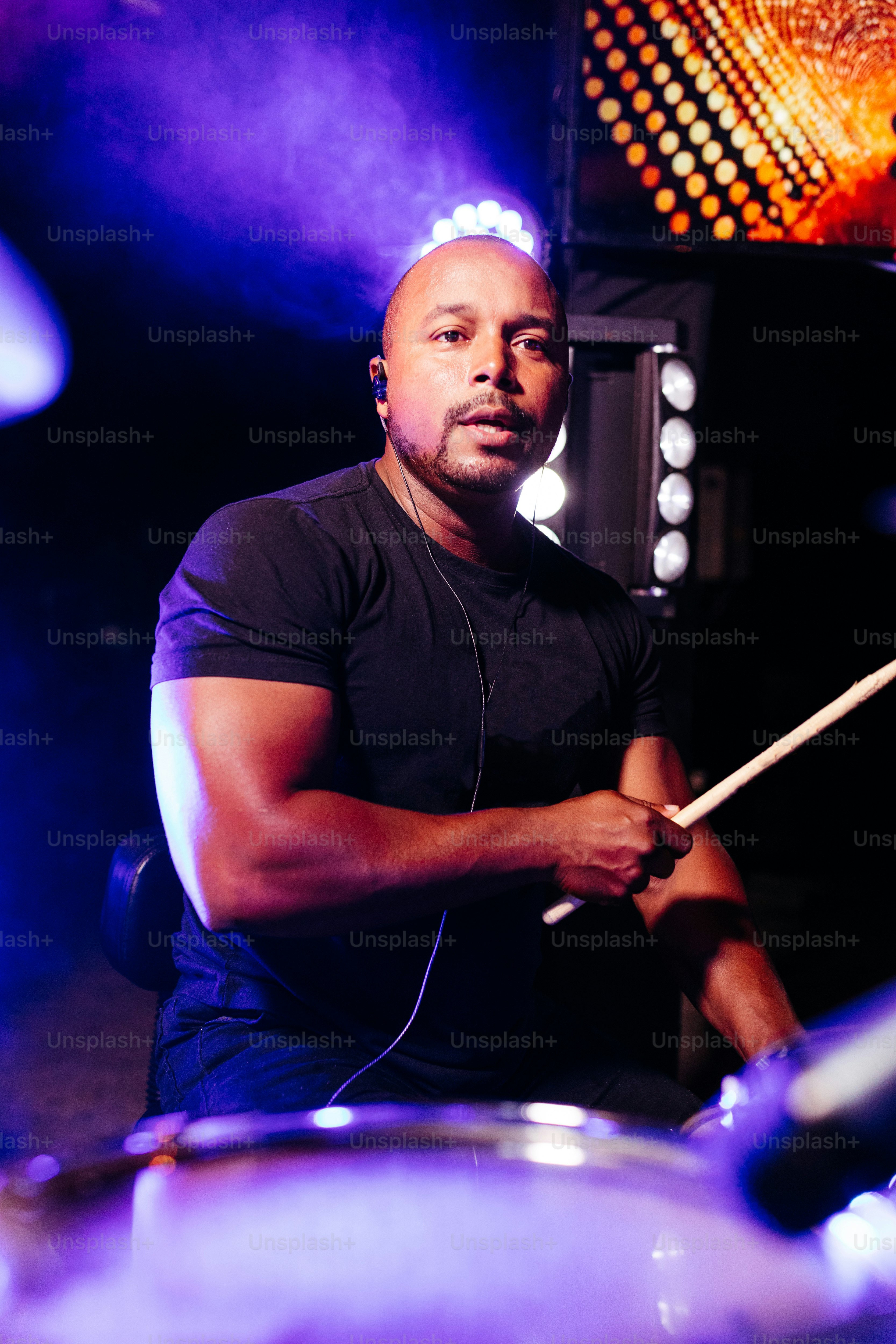 A man sitting in front of a drum set photo – Gig Image on Unsplash