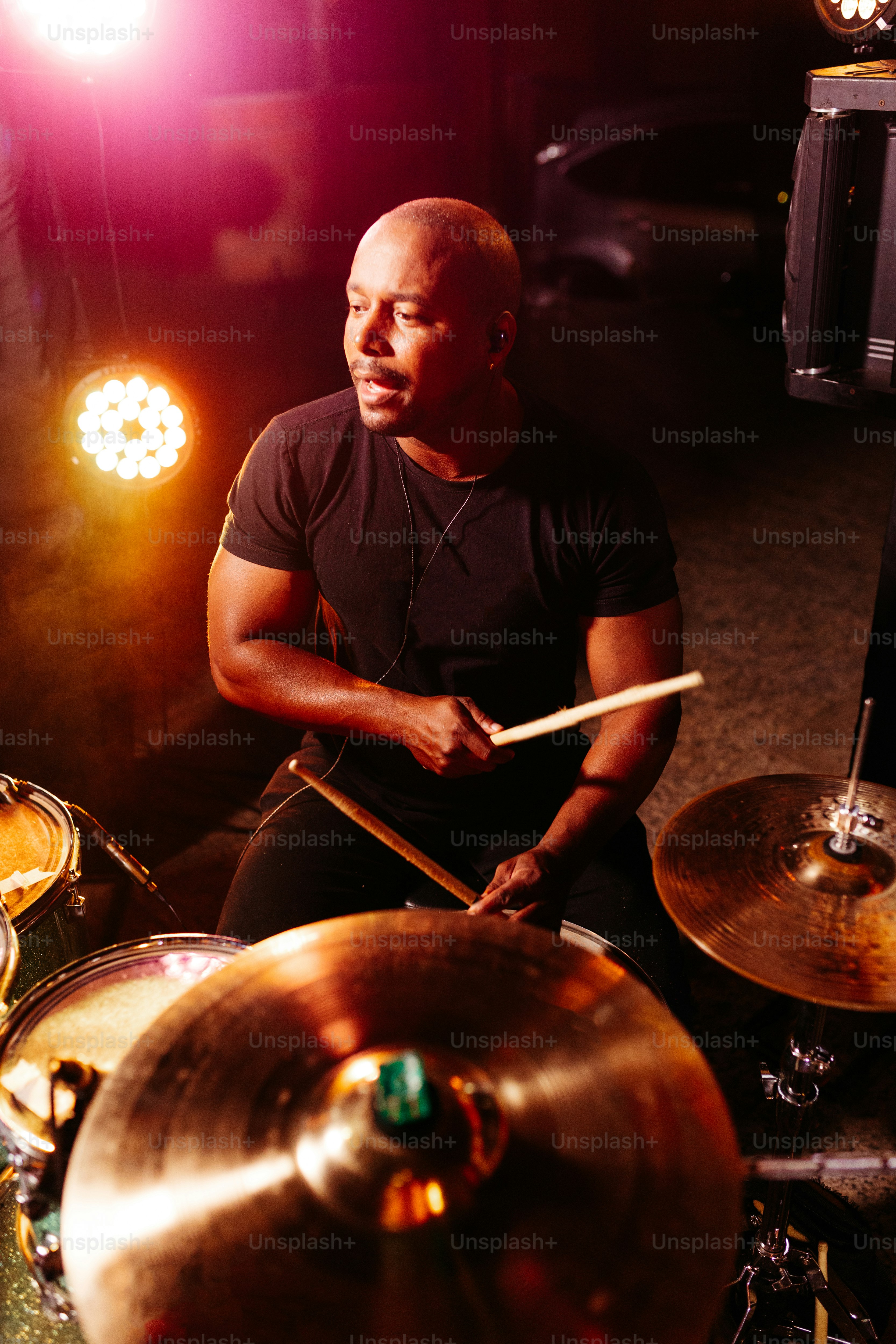 A man sitting in front of a drum set photo – Performer Image on Unsplash