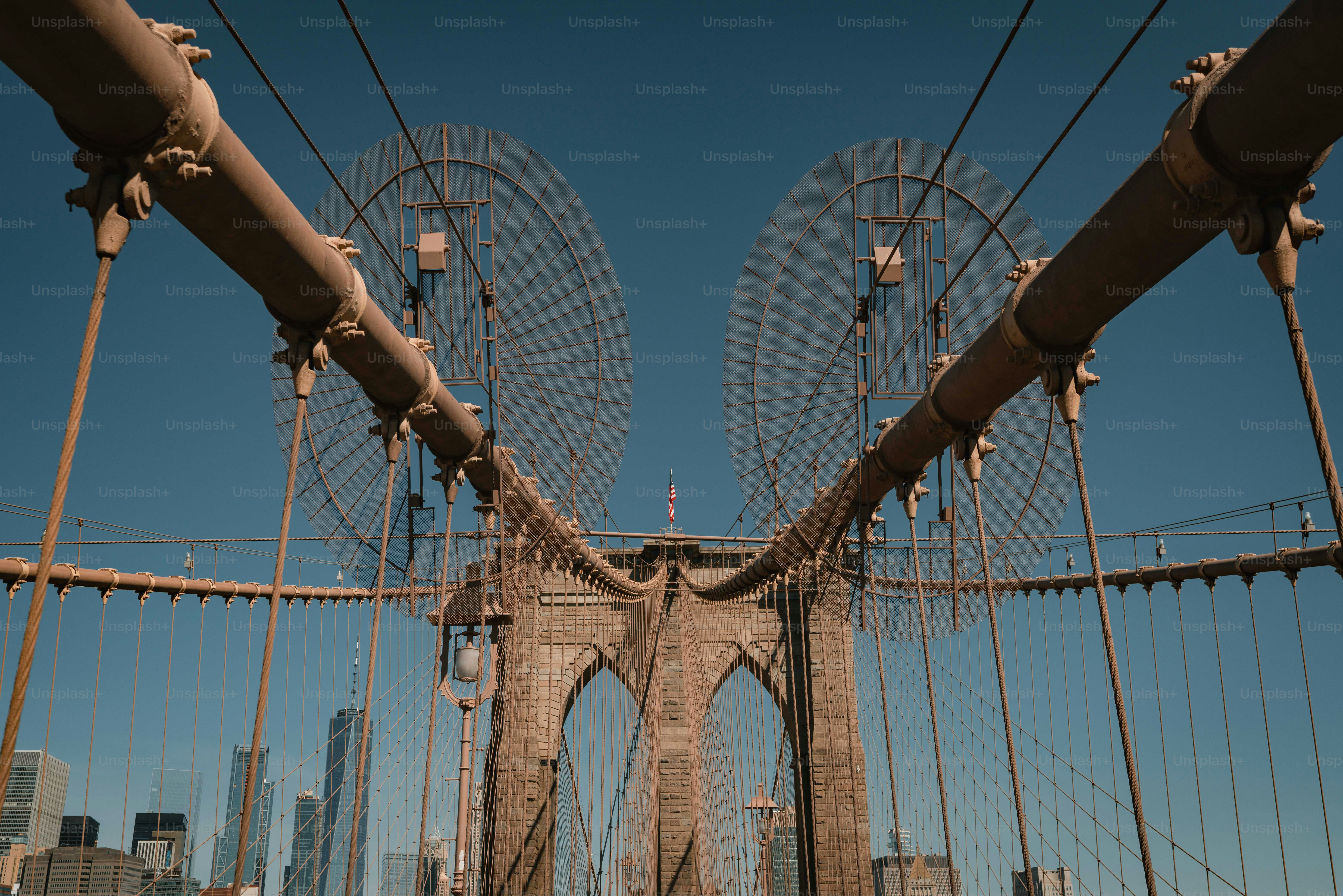 A view of a bridge with a ferris wheel in the background photo – New ...