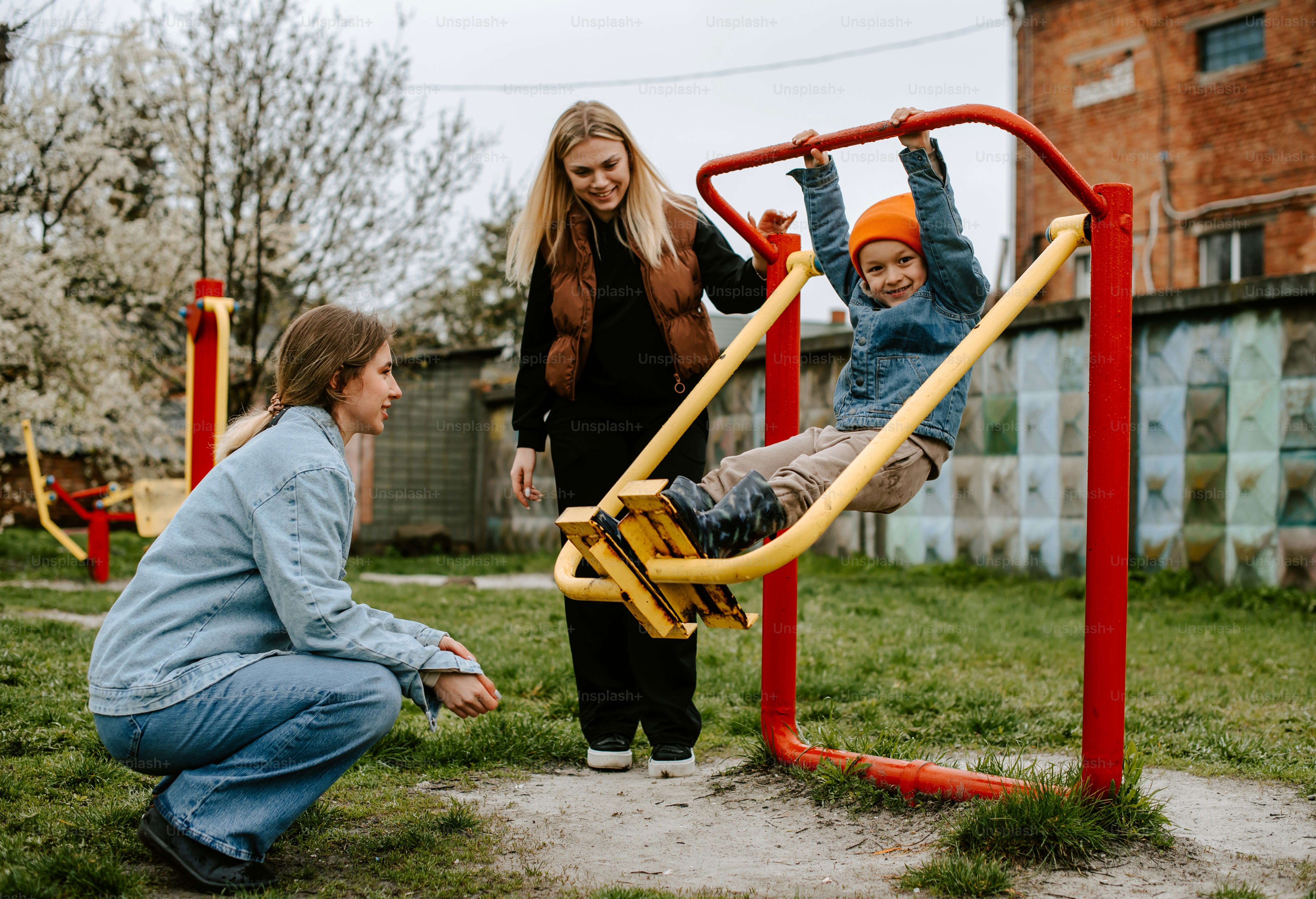 A woman and a child playing on a playground photo – Family Image on ...