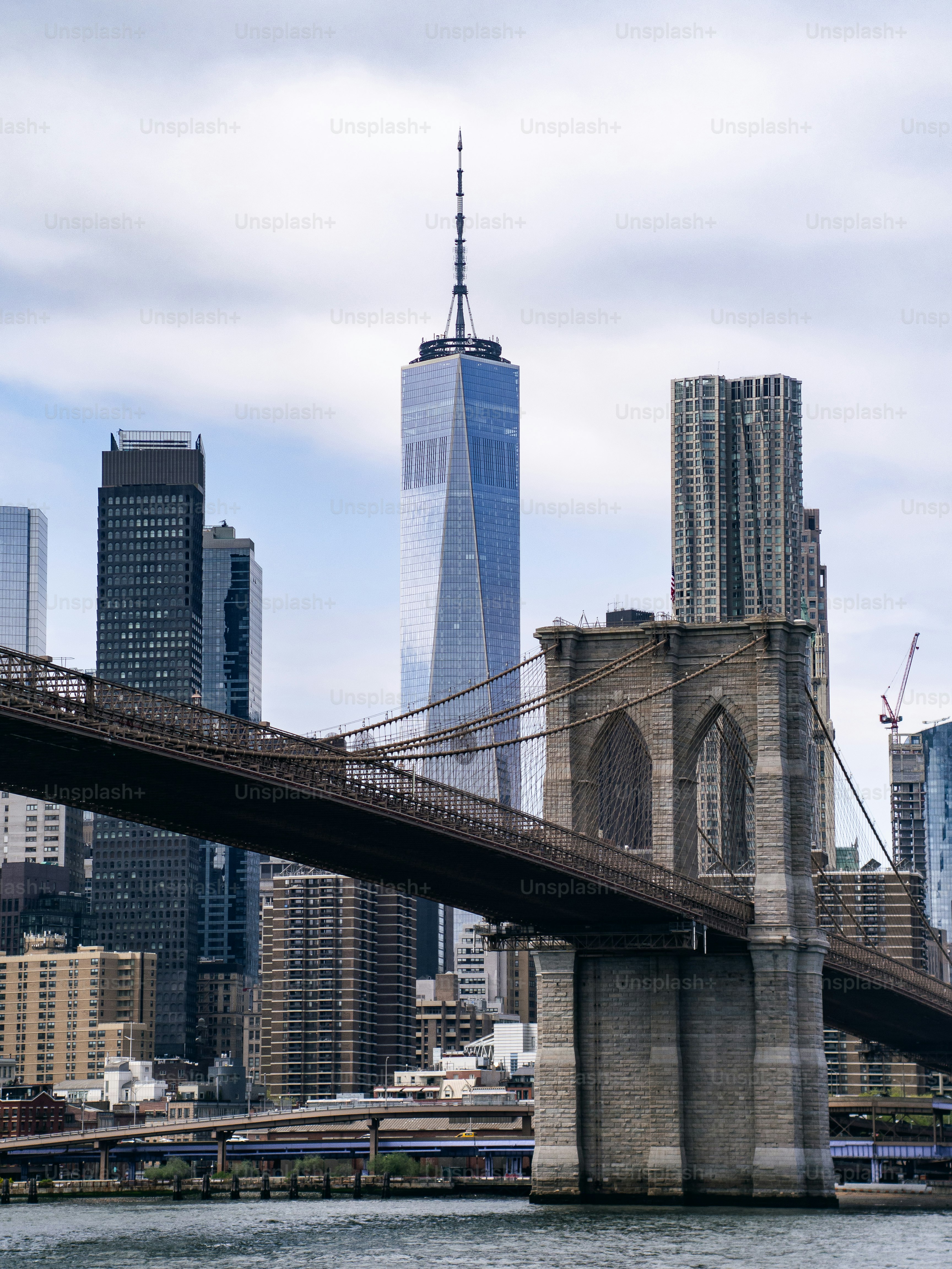 A view of a bridge with a city in the background photo – New york city ...