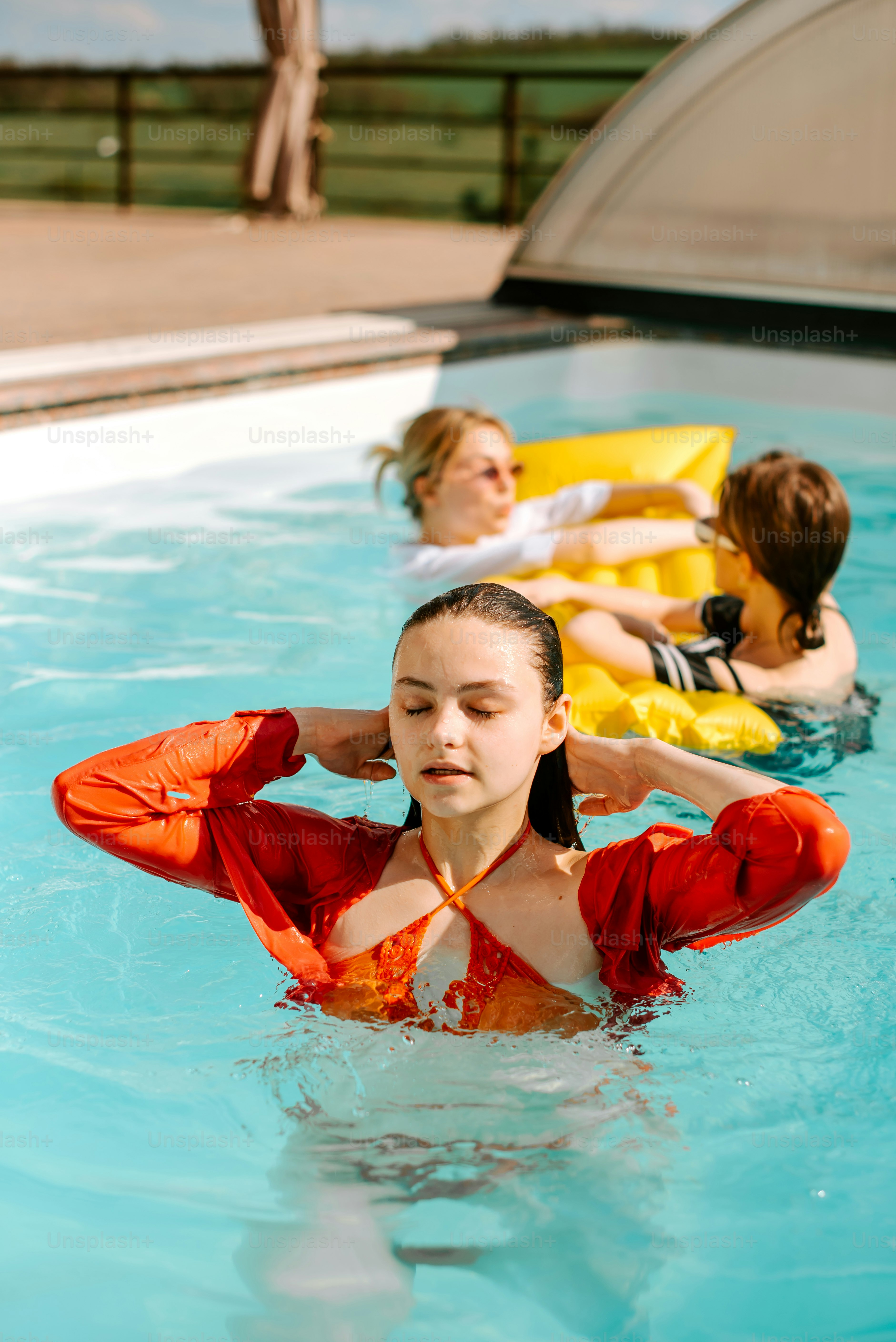 A group of people in a swimming pool photo – Pool party Image on Unsplash