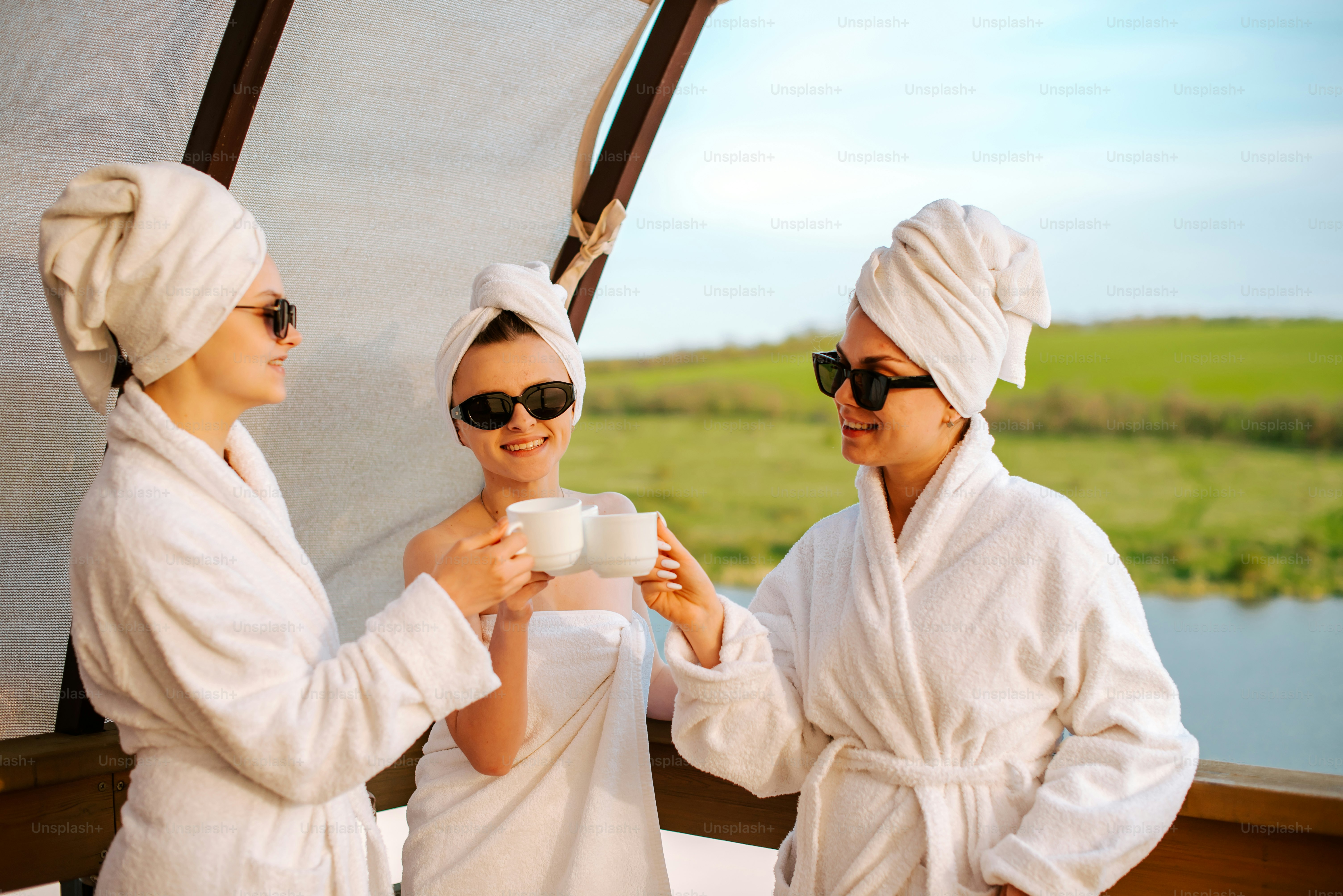 A group of people toasting with drinks in a pool photo – People Image ...