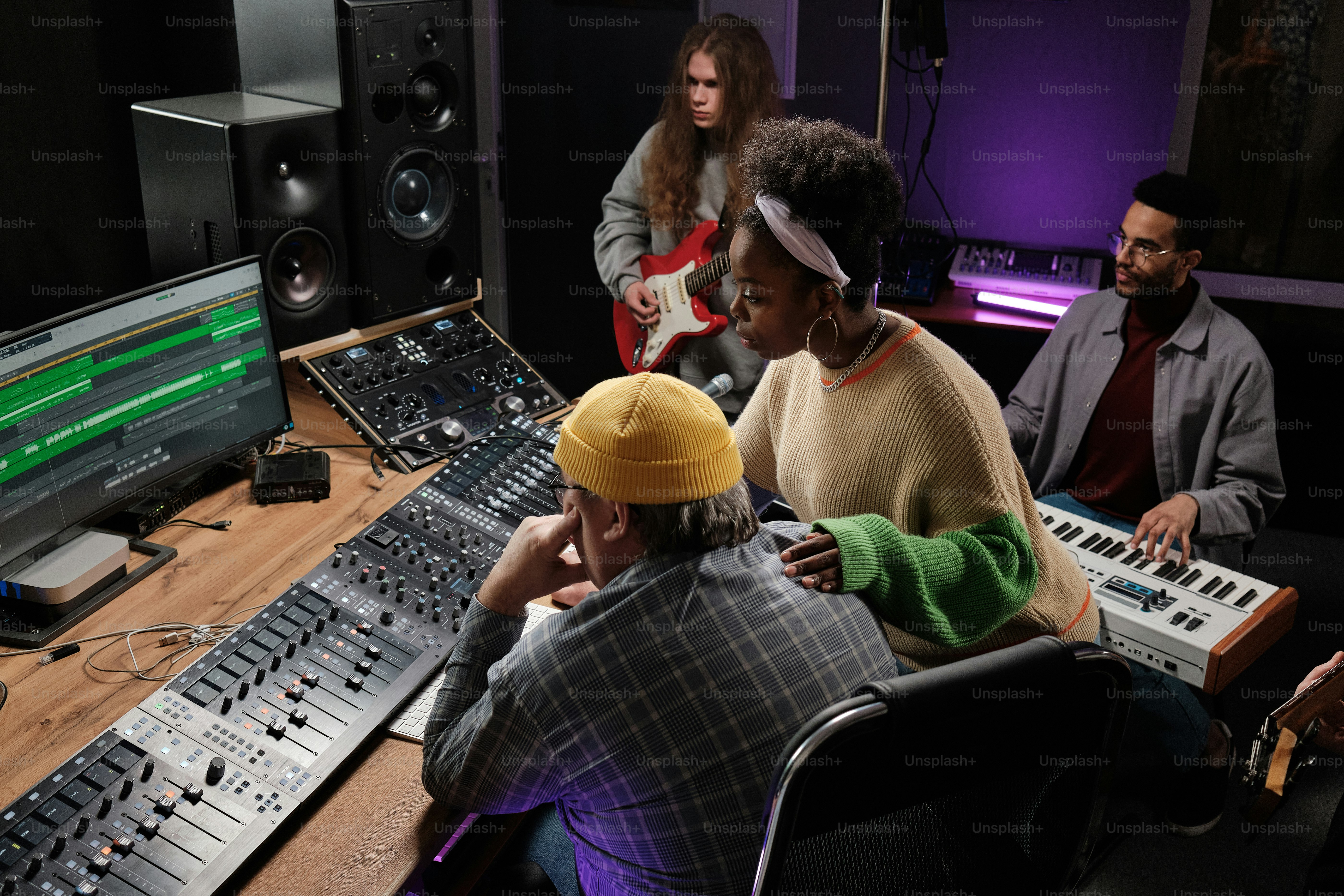 A group of people in a recording studio photo – Musicians Image on Unsplash