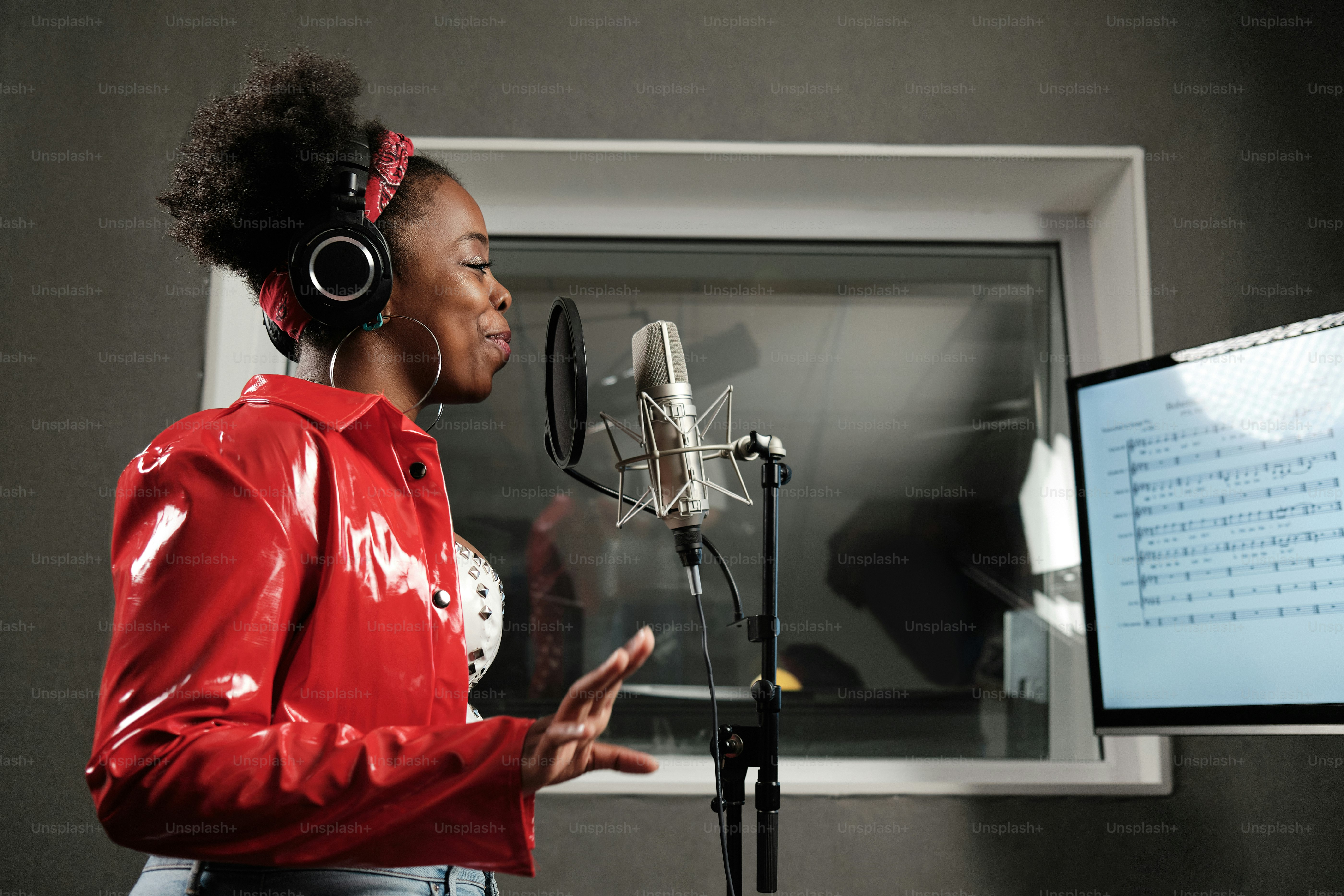 A woman standing in front of a microphone photo – Audition Image on ...