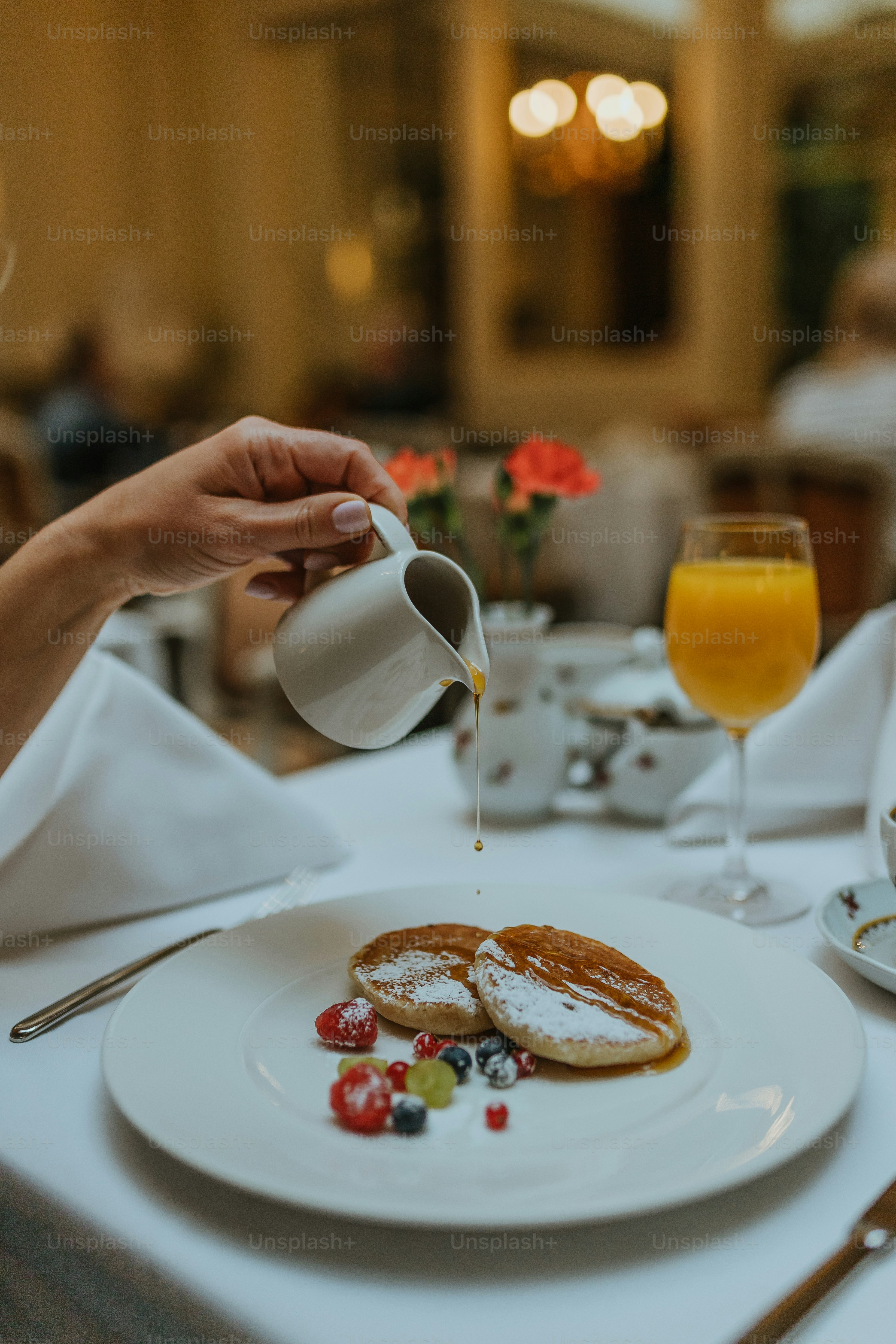 A person pouring syrup on a plate of food photo – Syrup Image on Unsplash