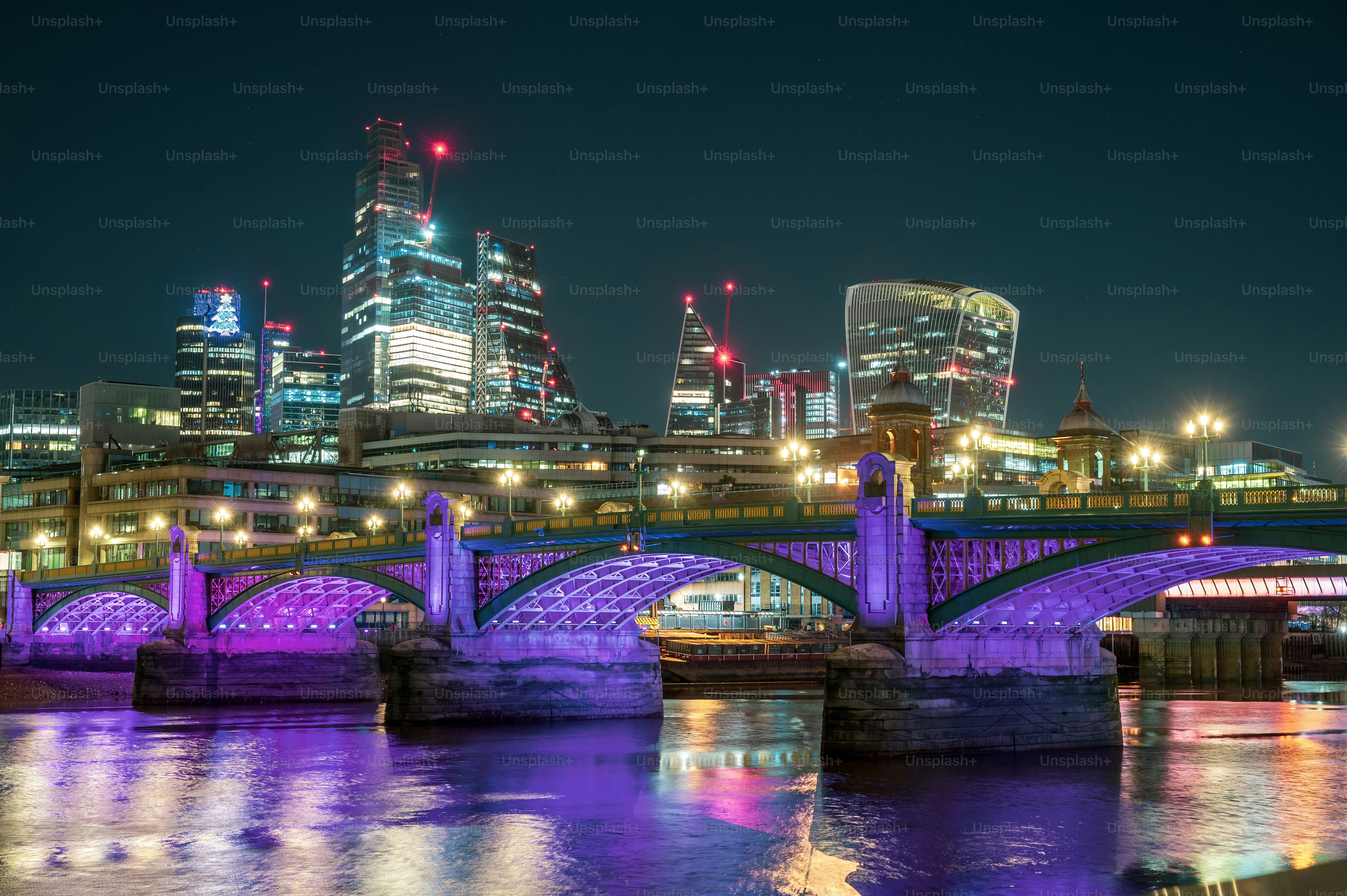 A view of a city in the distance with a bridge in the foreground photo ...
