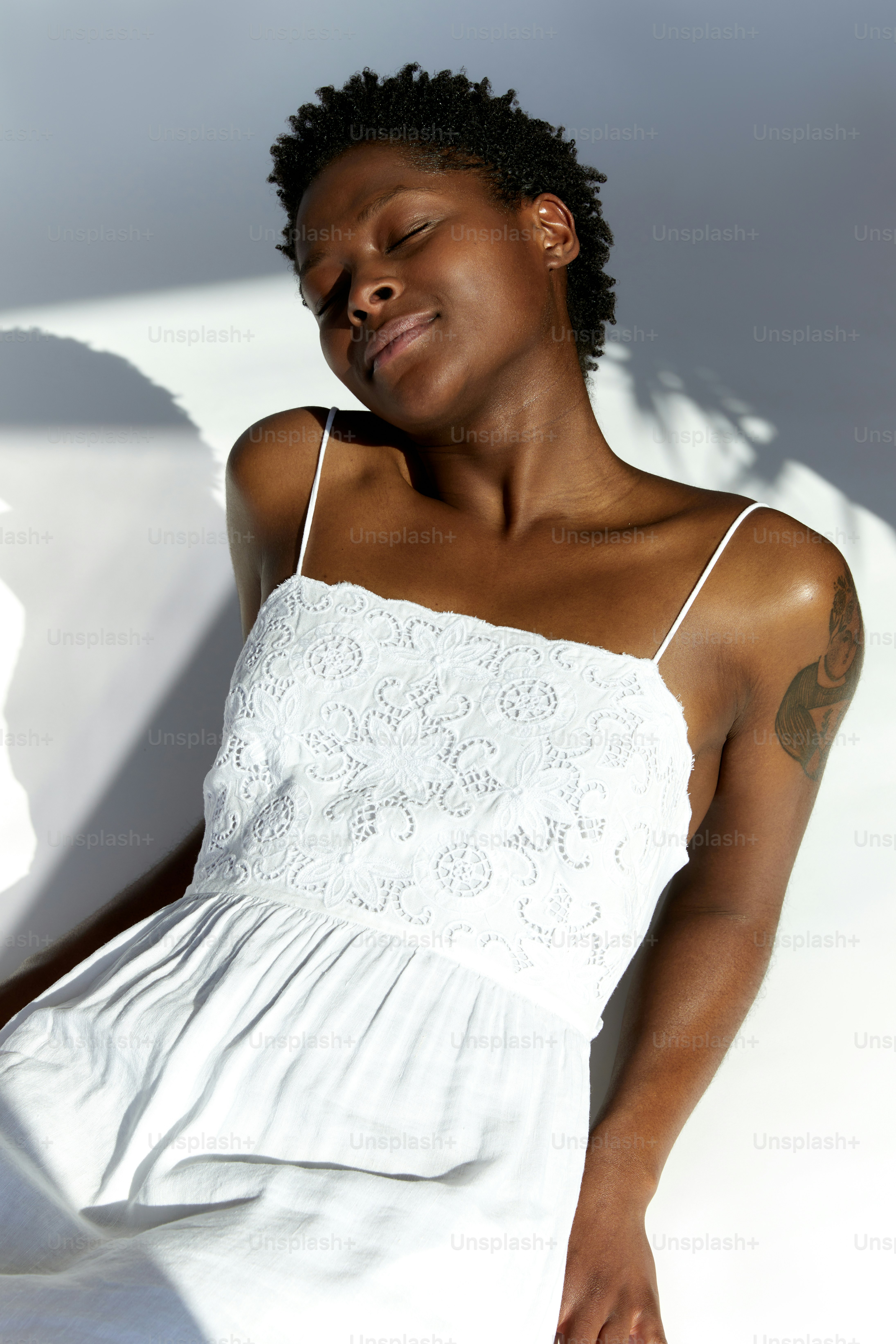 A woman in a white dress posing for a picture photo – Bare face Image ...