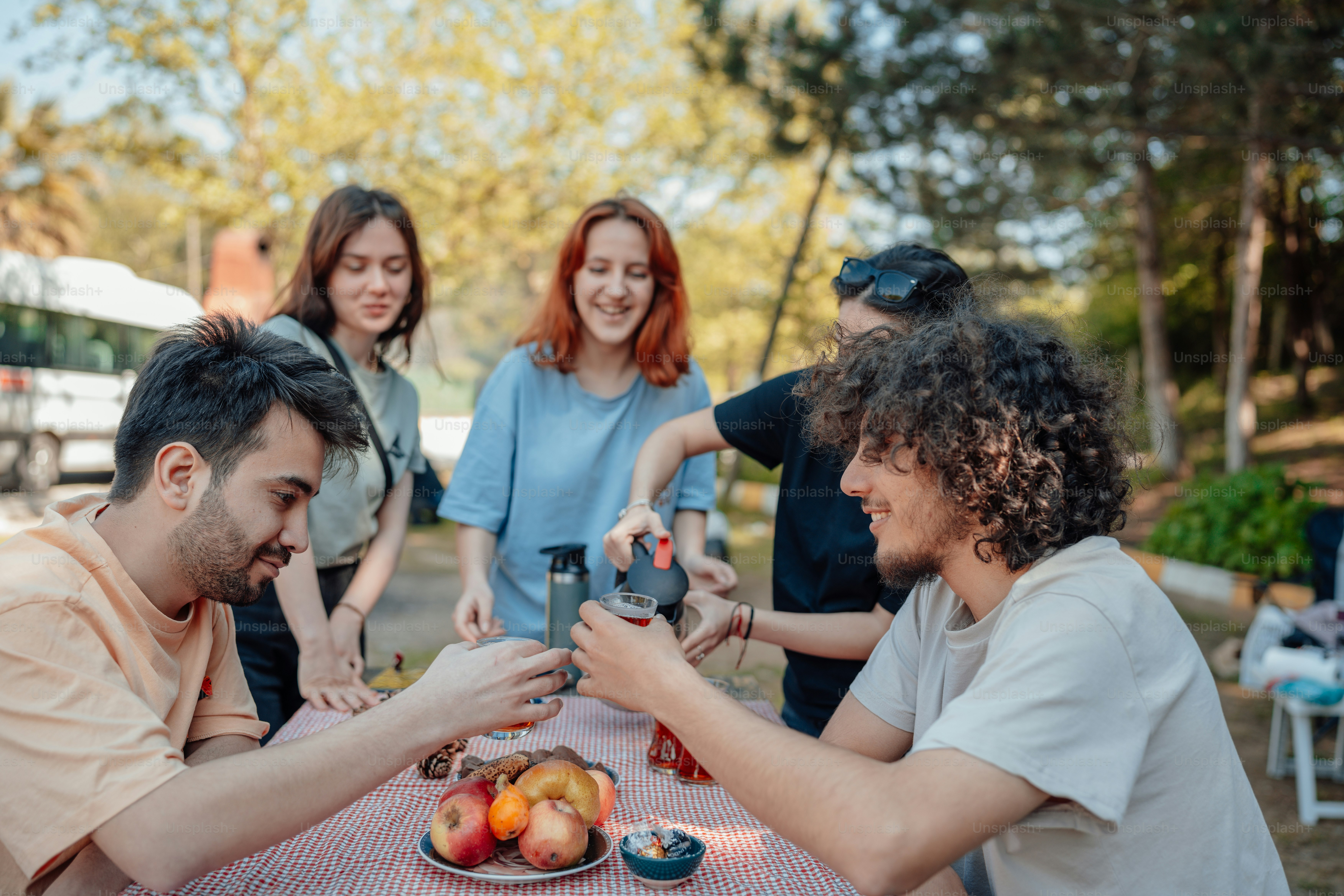 A group of people sitting around a table eating food photo – Eating ...
