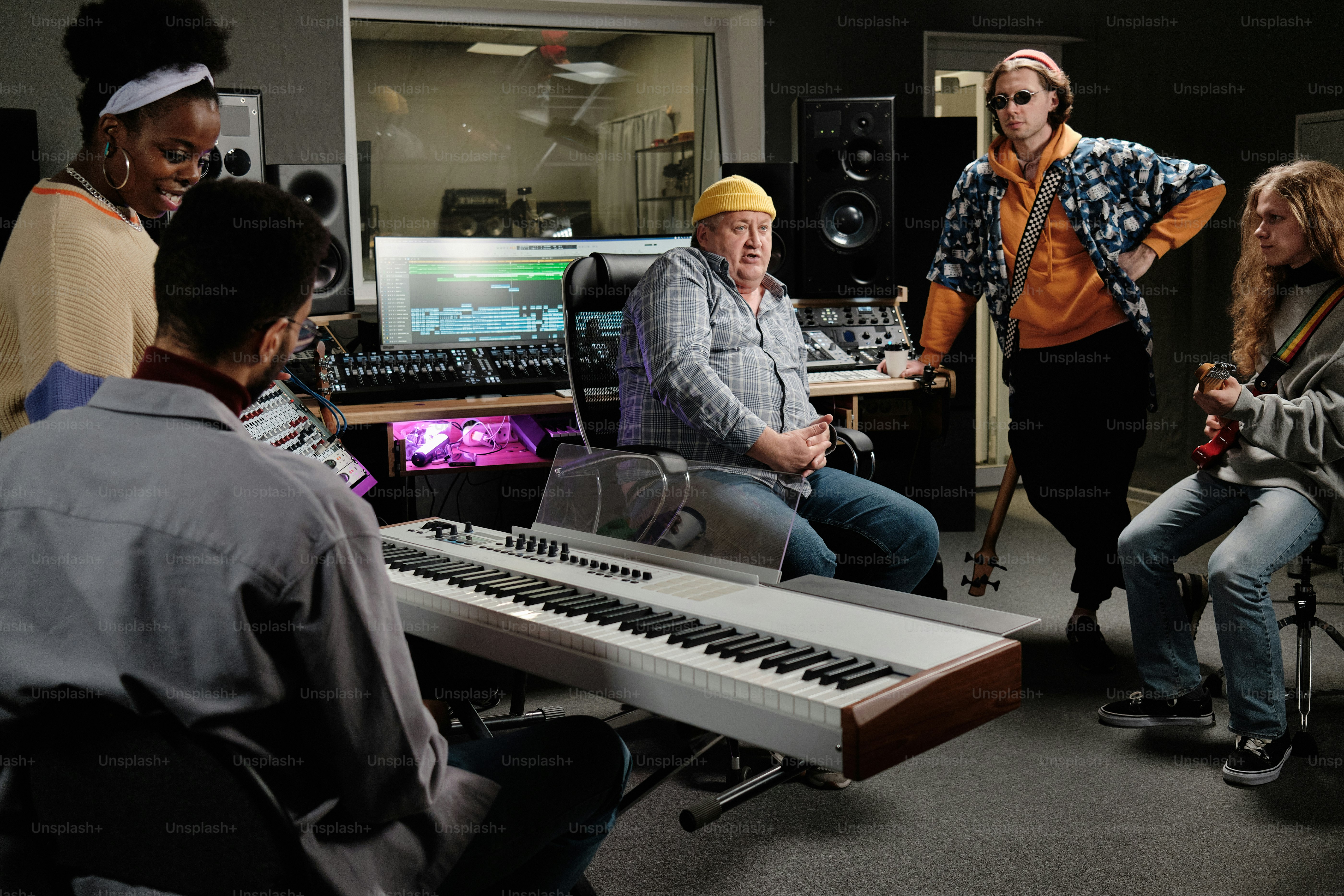 A group of people in a recording studio photo – Musicians Image on Unsplash