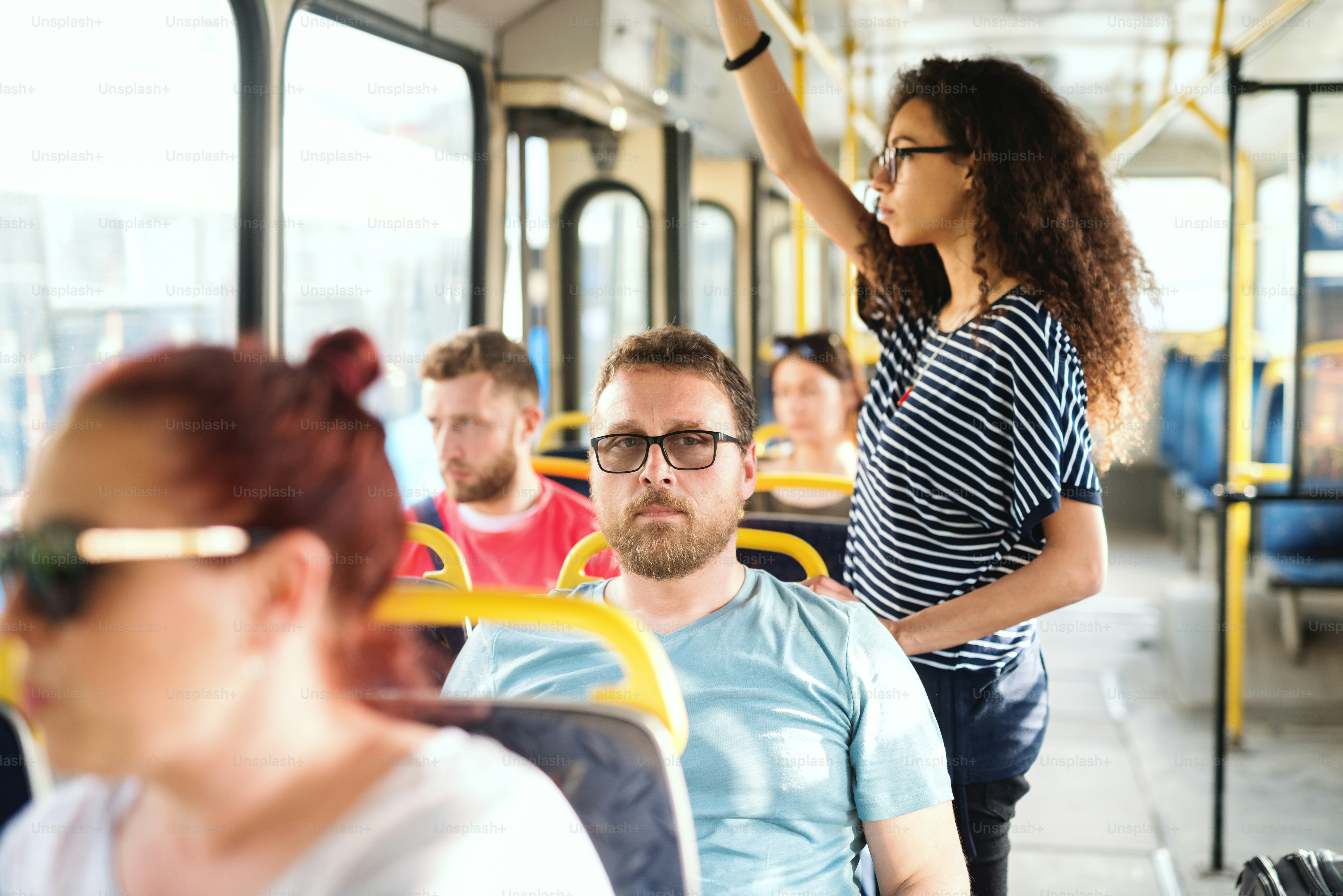 Multicultural group of people riding in the city bus. photo – People ...