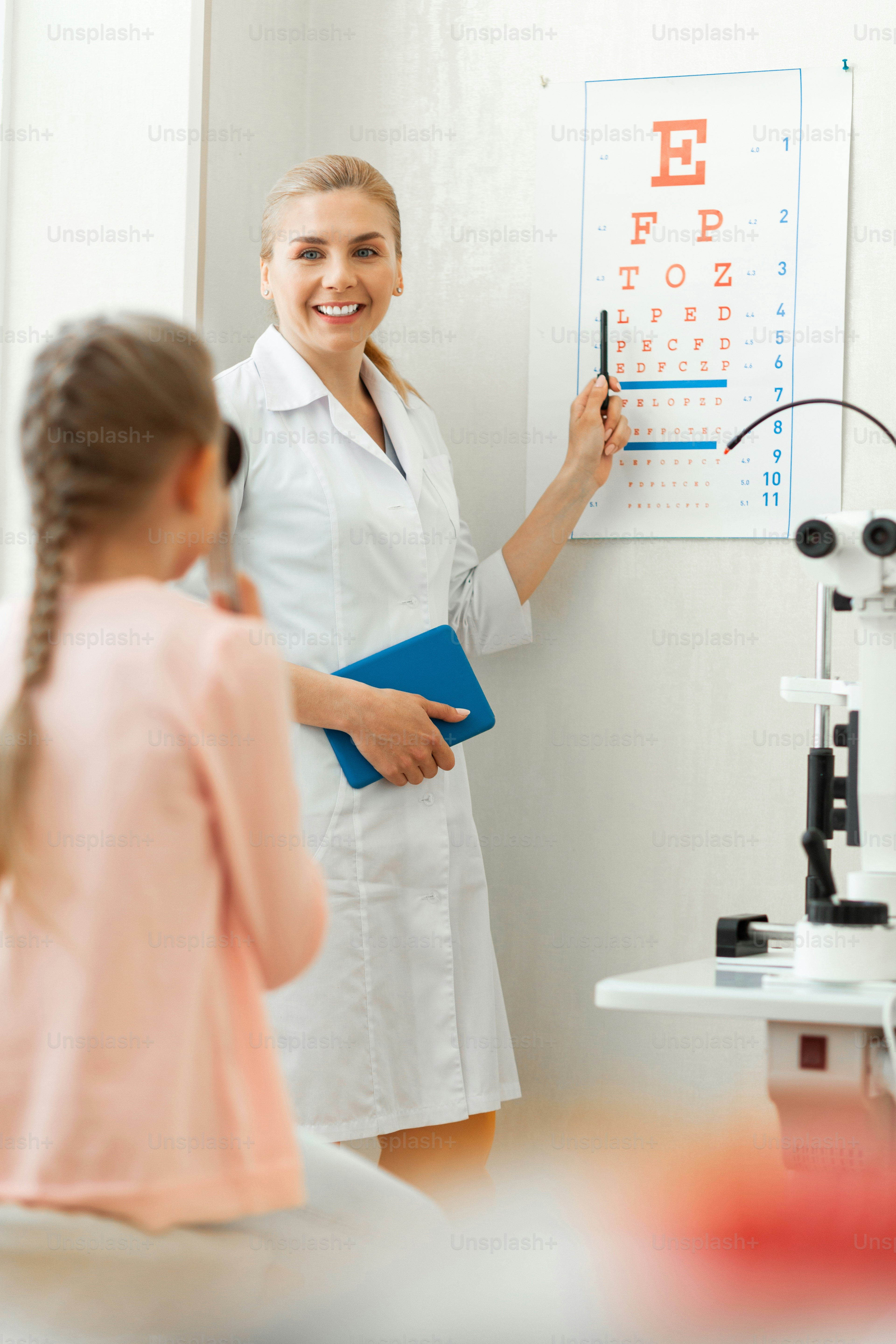 Observing checking poster. Beaming pleasant woman in white robe dealing ...