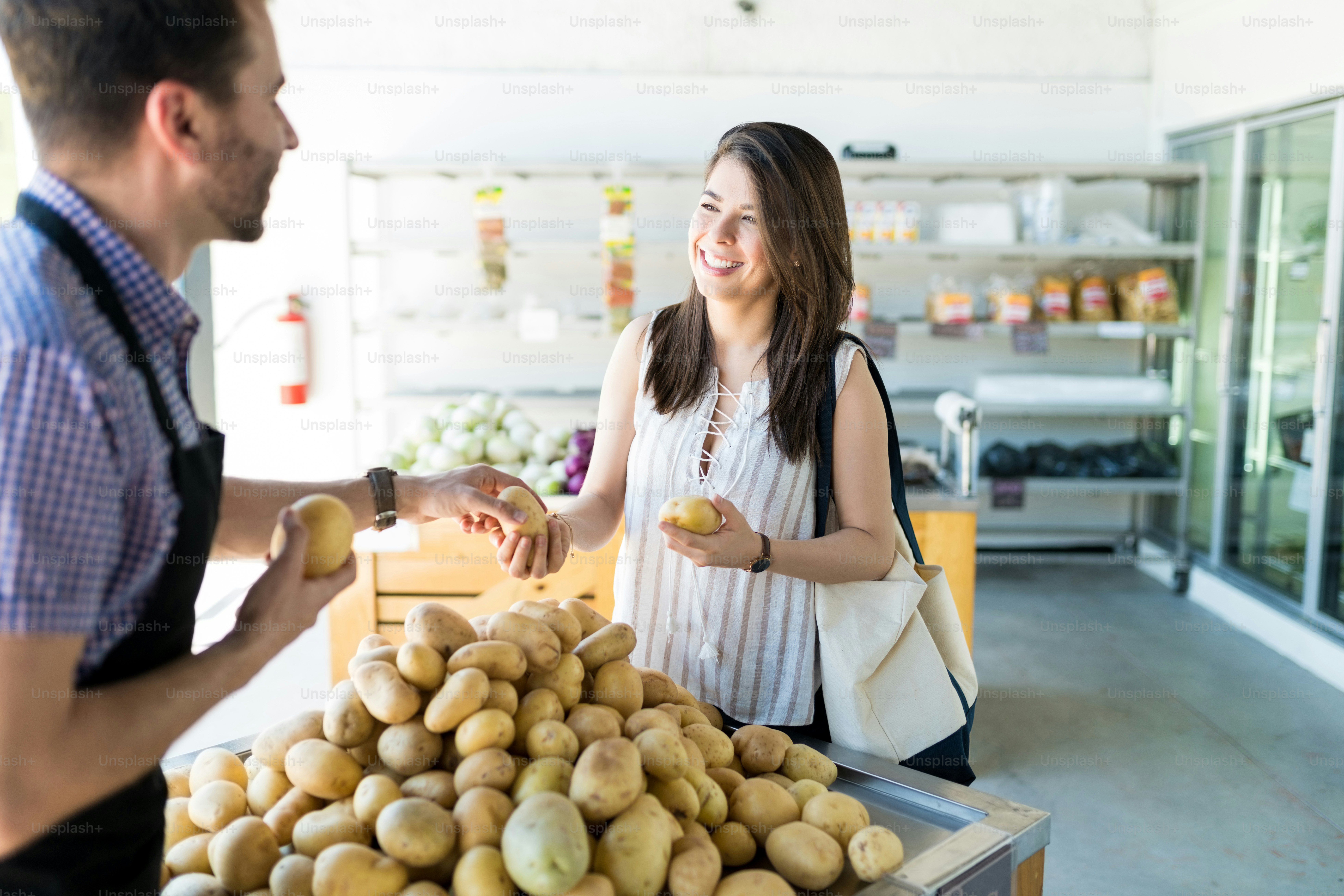 Smiling shopper getting some assistance from store owner in selecting ...