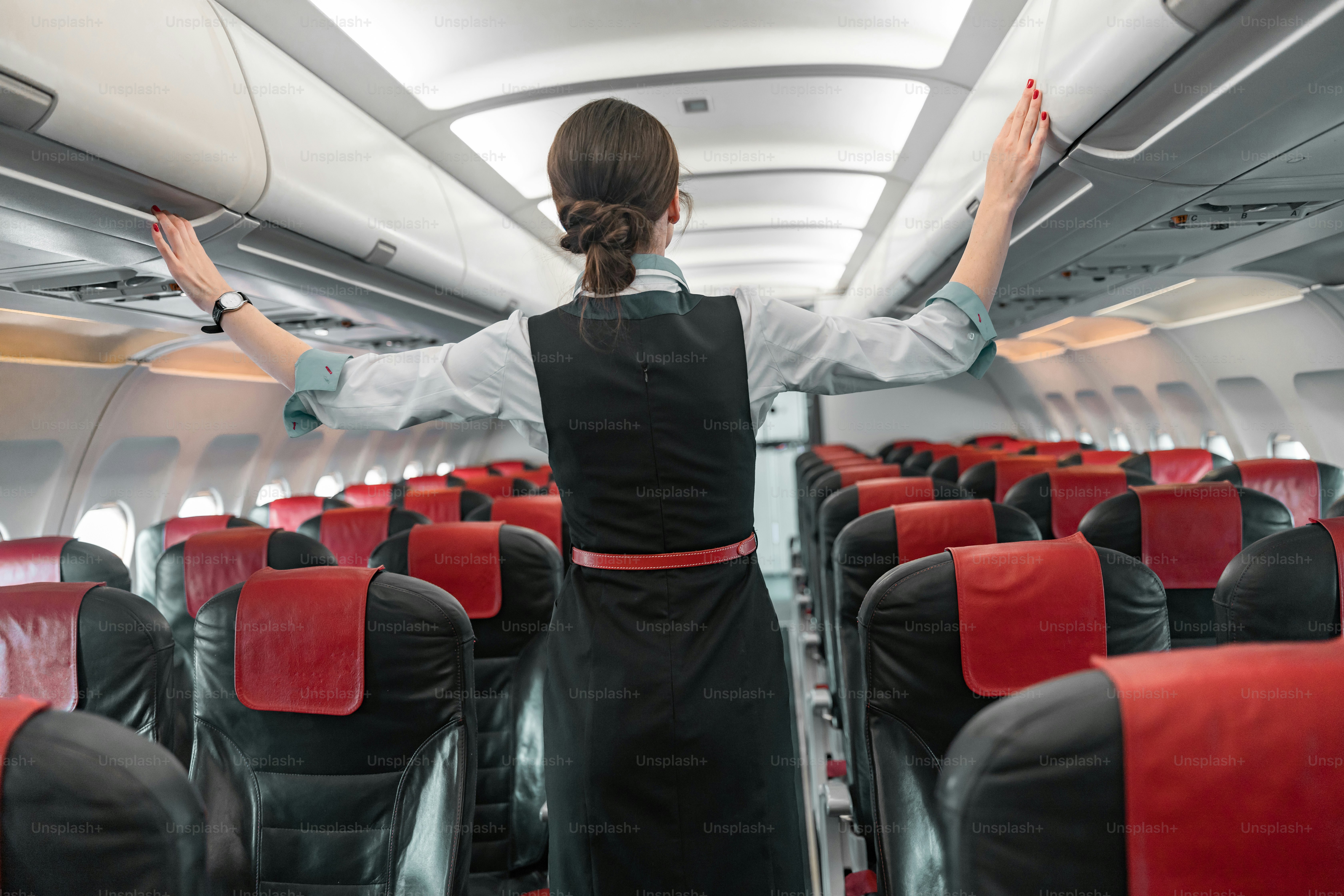 Female flight attendant doing her job in airplane stock photo. Airways ...