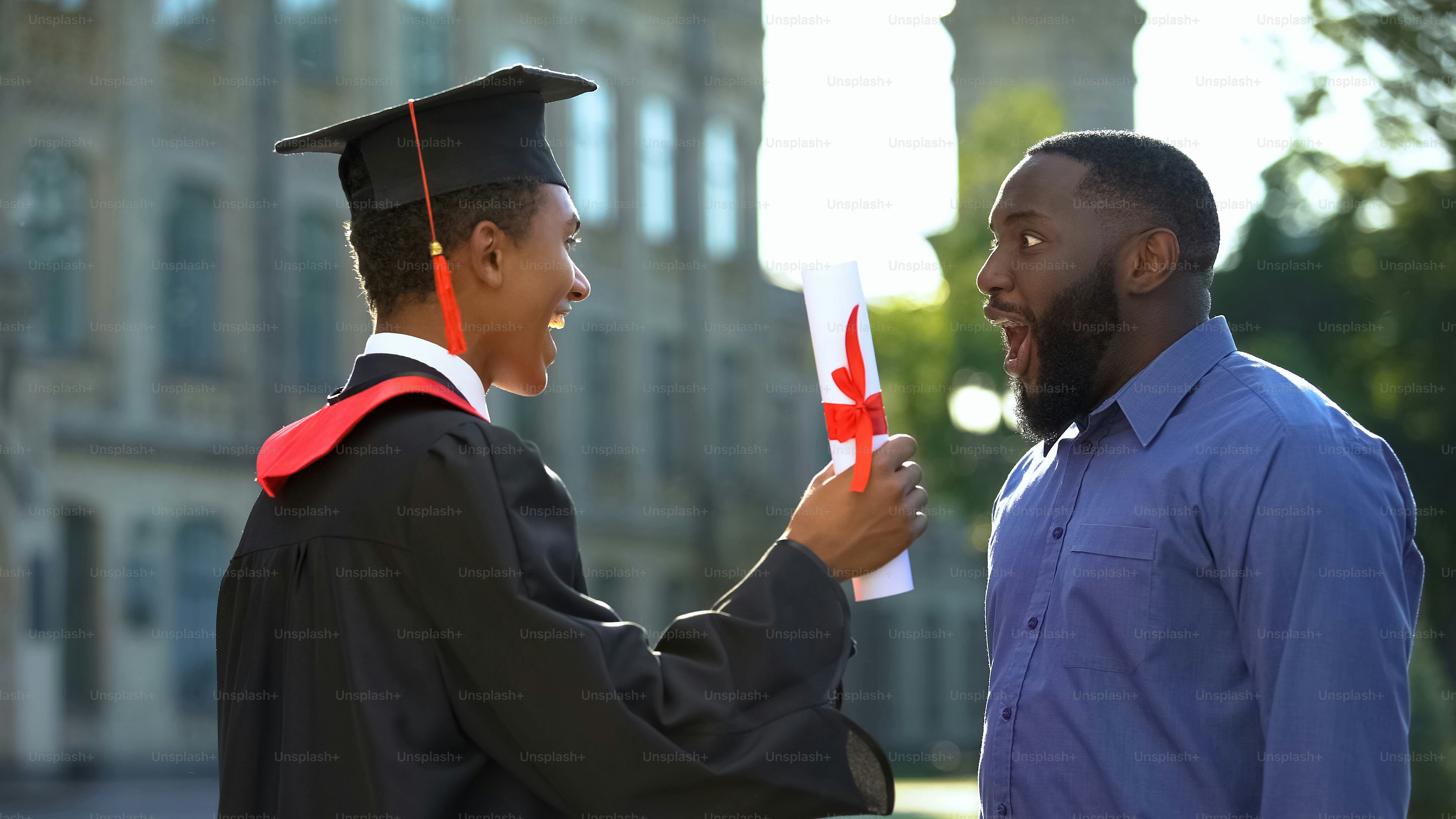 Excited dad rejoicing graduating son with diploma, study achievement ...