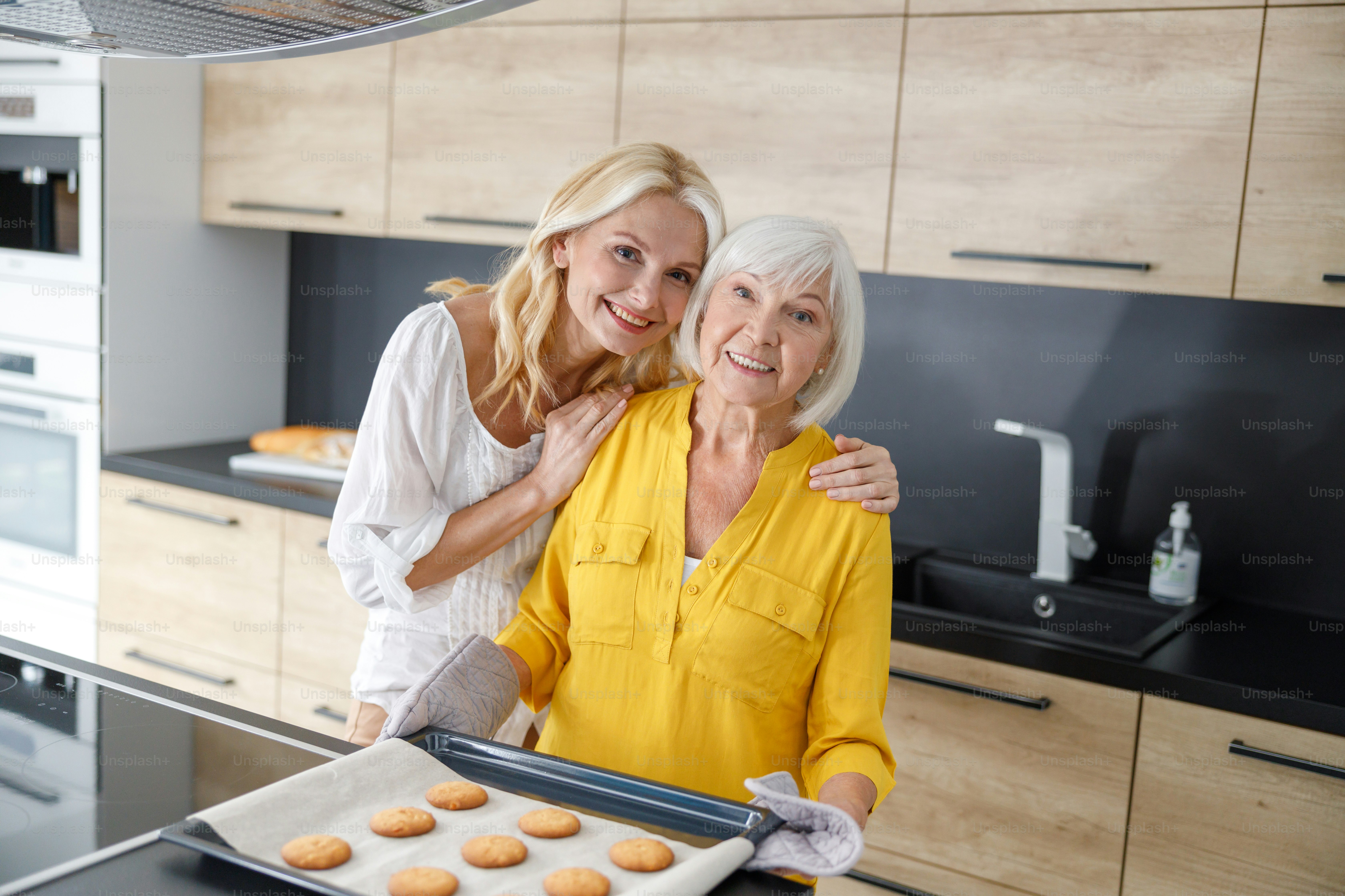 Happy adult women baking pastries together stock photo photo – Cooking ...