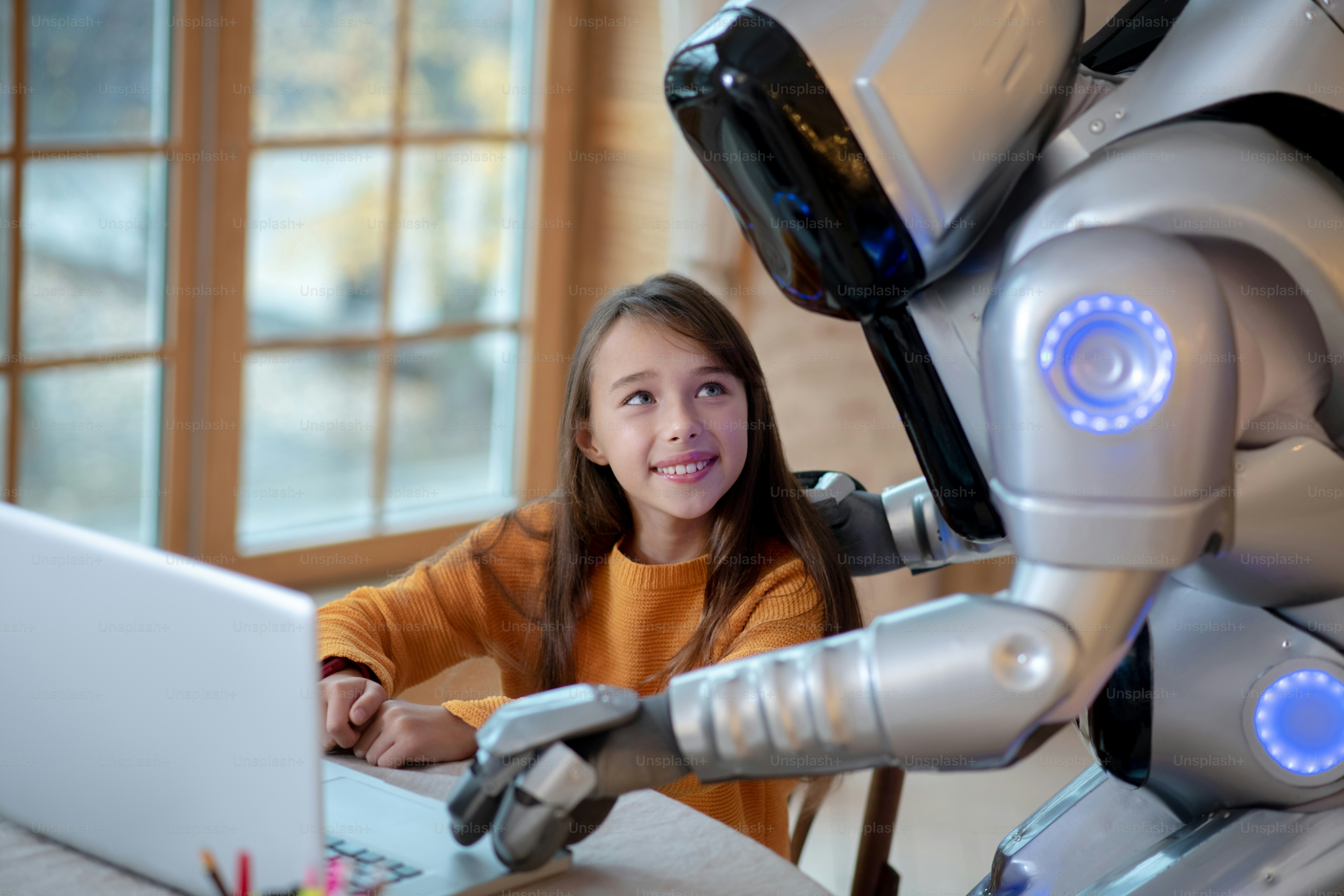 Lets do it together. Robot helping a girl with her homework showing her ...