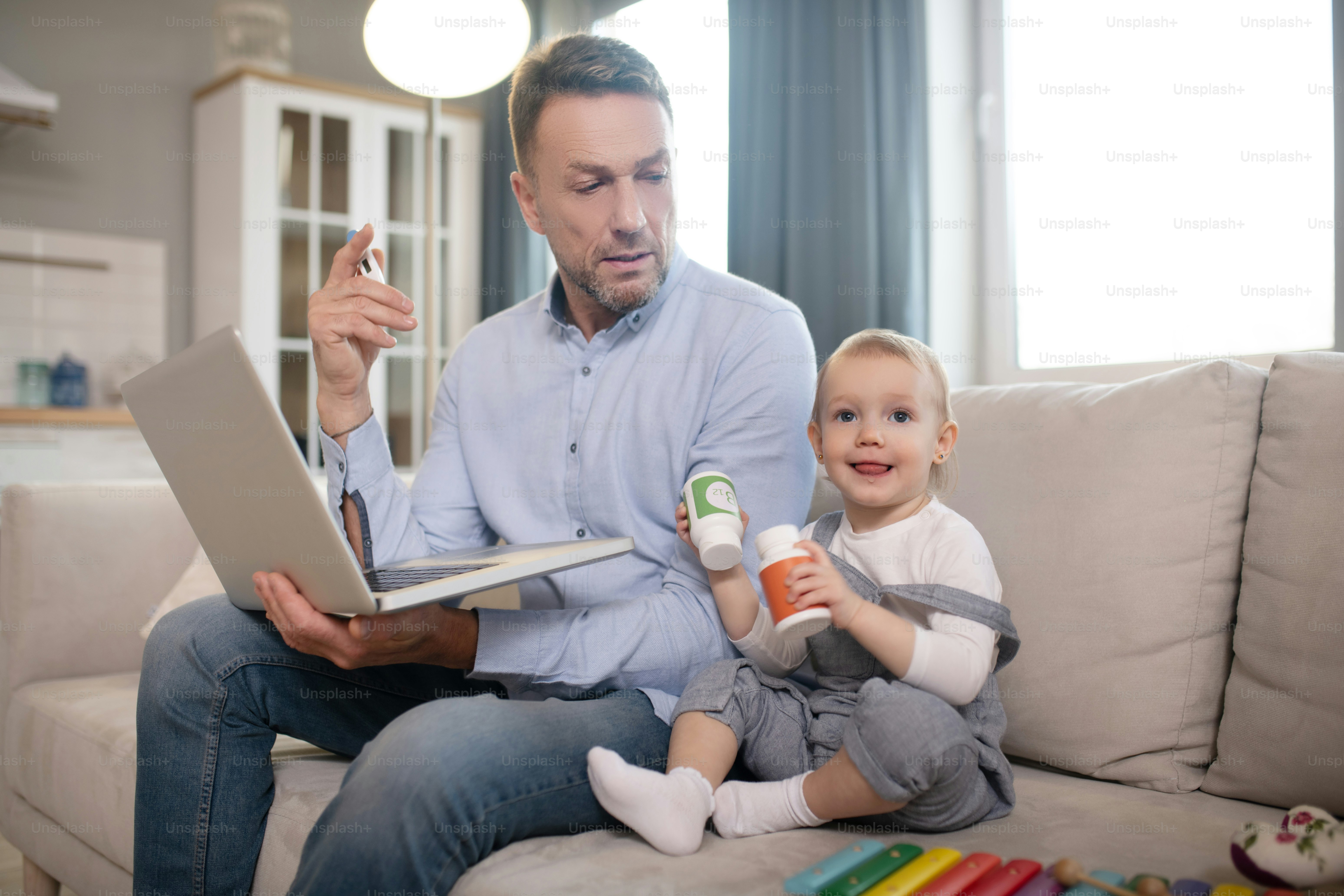 Working from home. Single father spending his time working from home ...