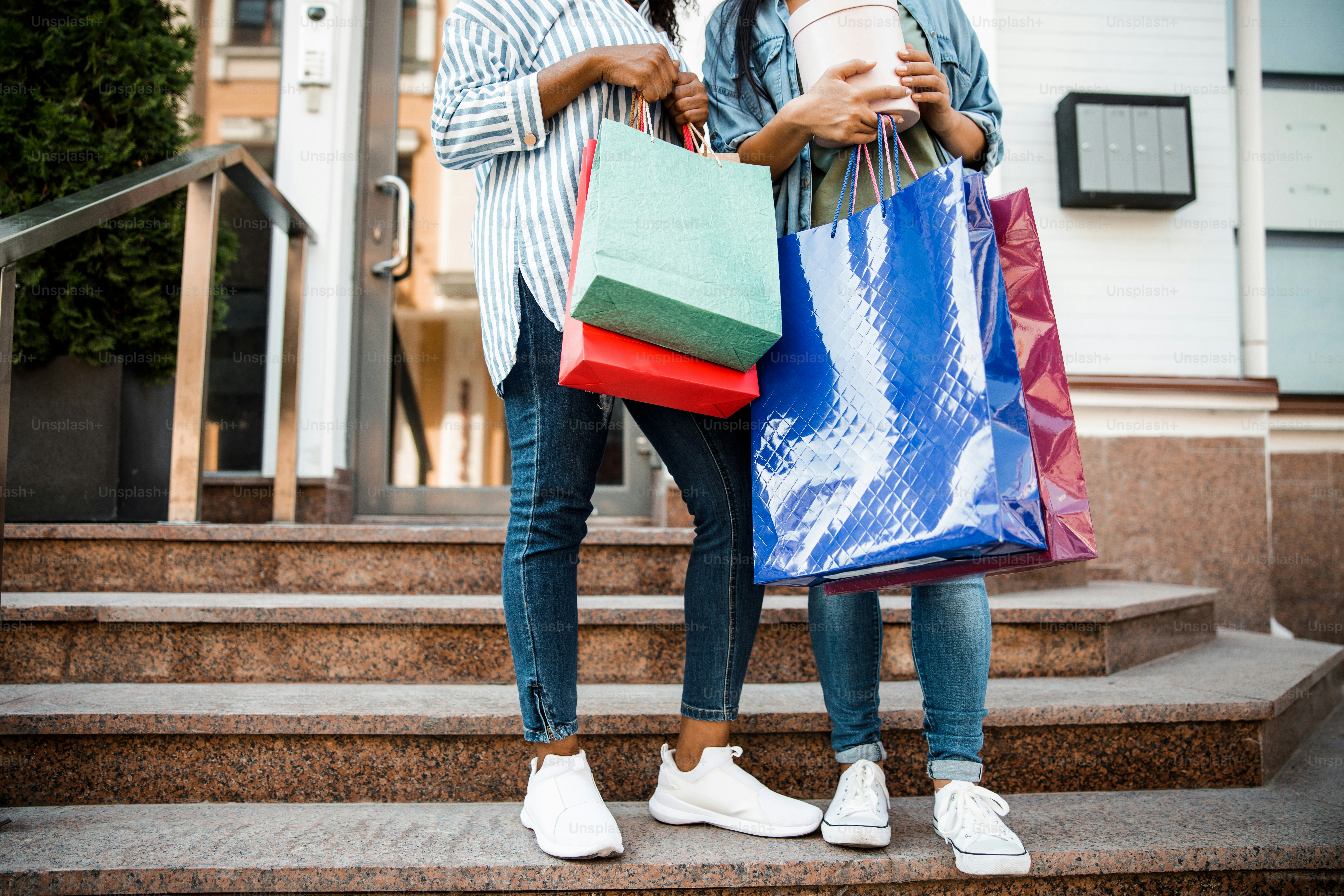 Cropped photo of young girls enjoying weekend. shopping concept photo ...