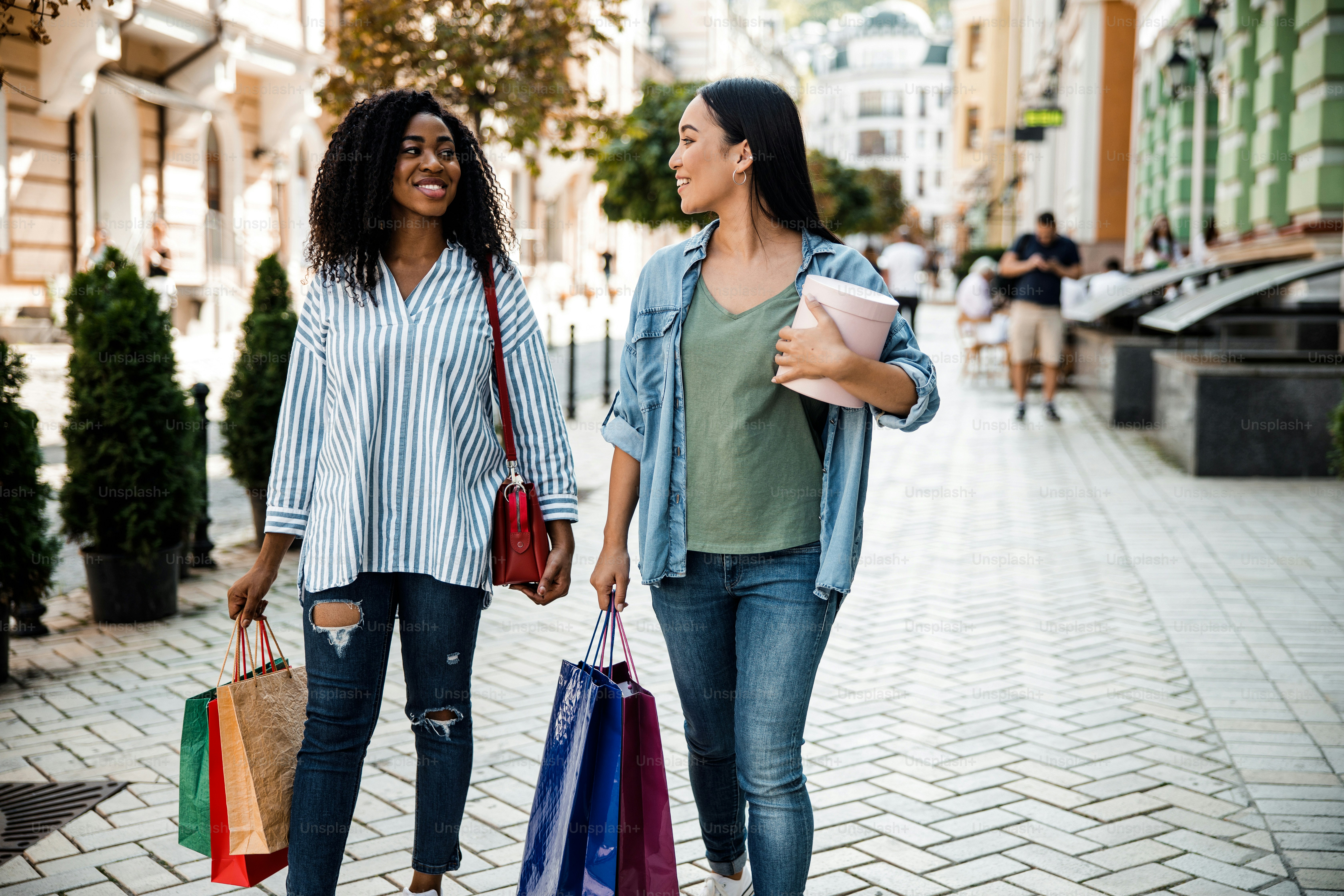 Young girls holding shopping bags in city. Shopping concept photo ...