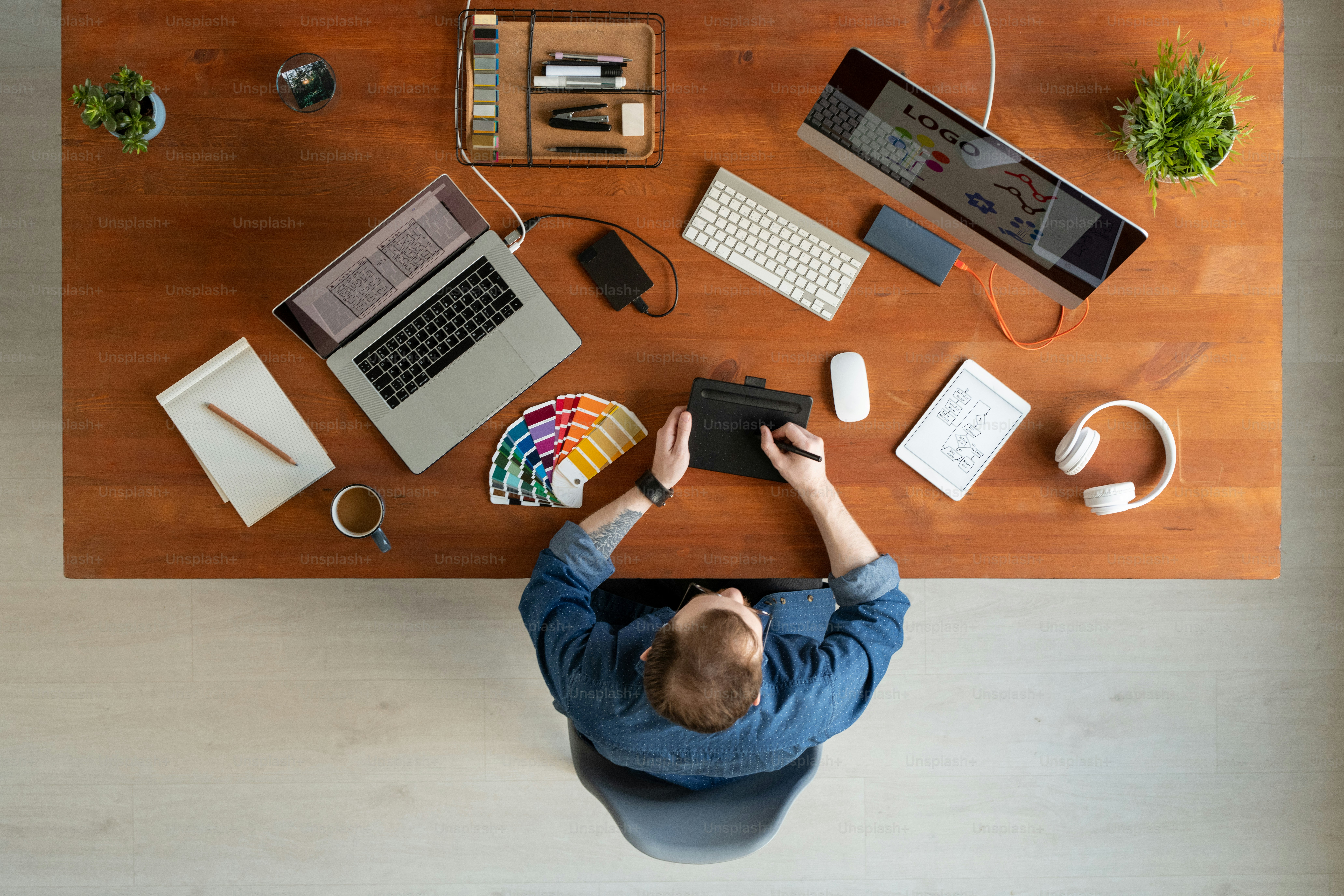 Overview of young creative software developer drawing on tablet display ...