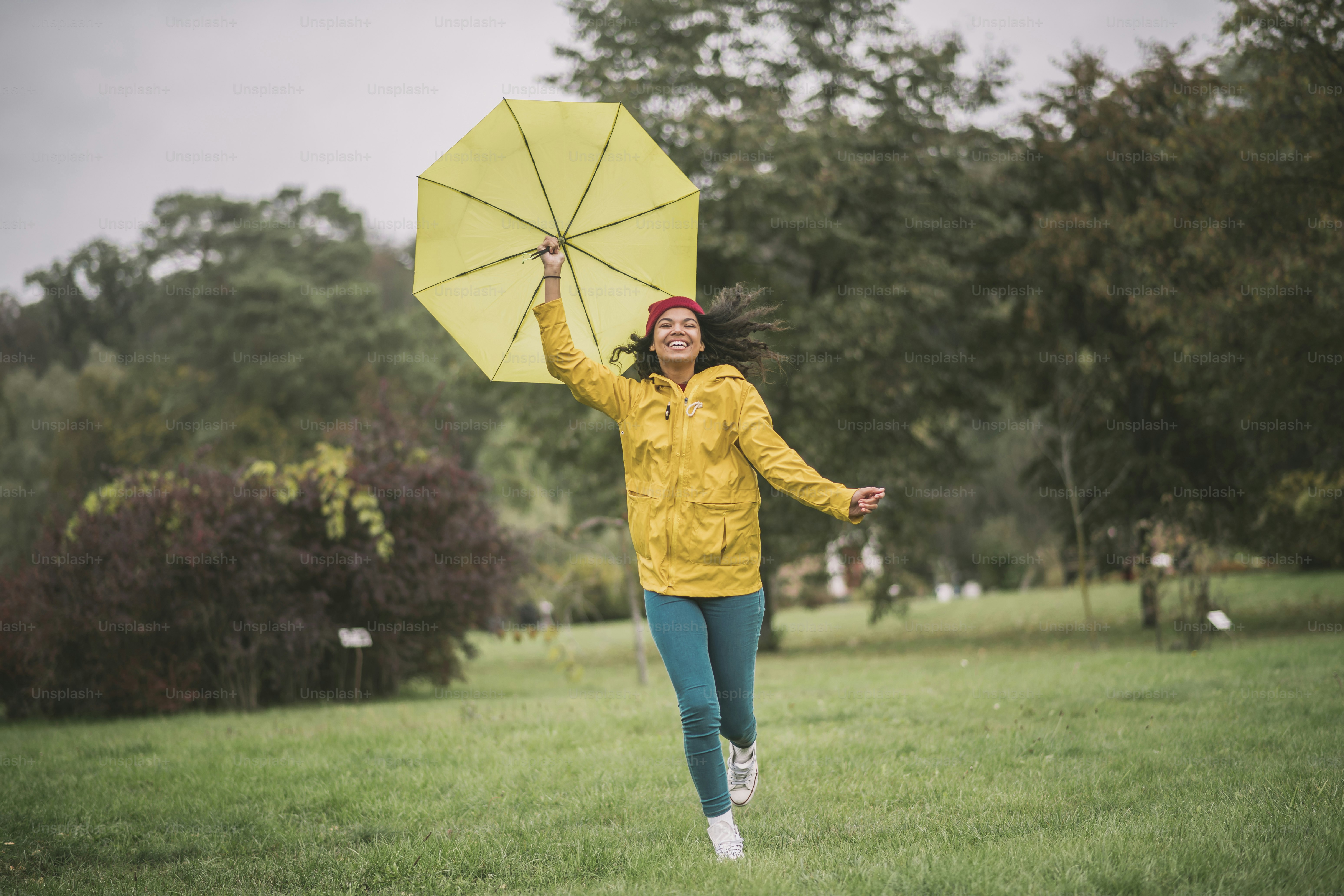 Fun. Cute mulatta with yellow umbrella running and having fun photo ...