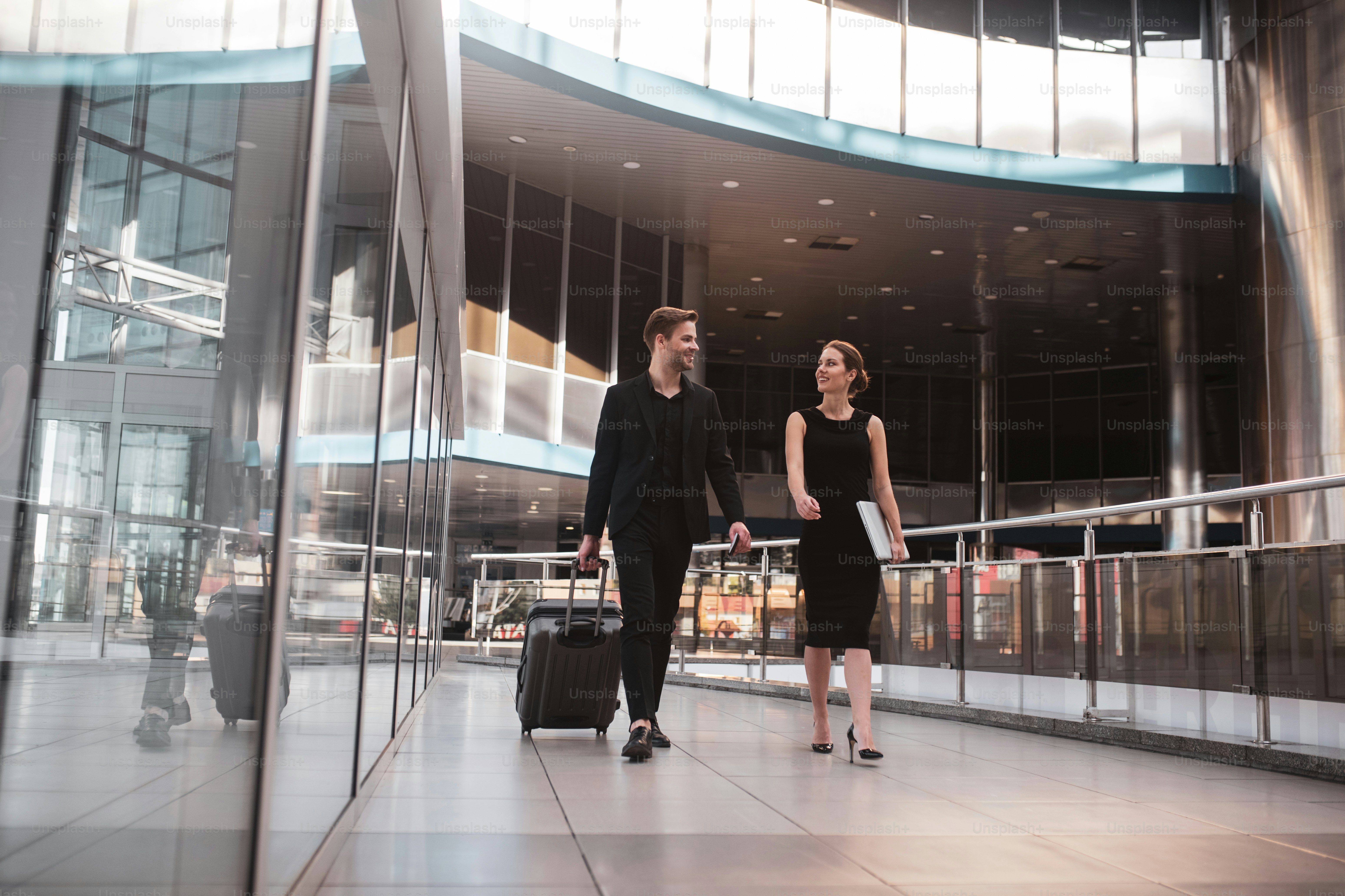Business trip. Man and woman arriving at the airport for the business ...