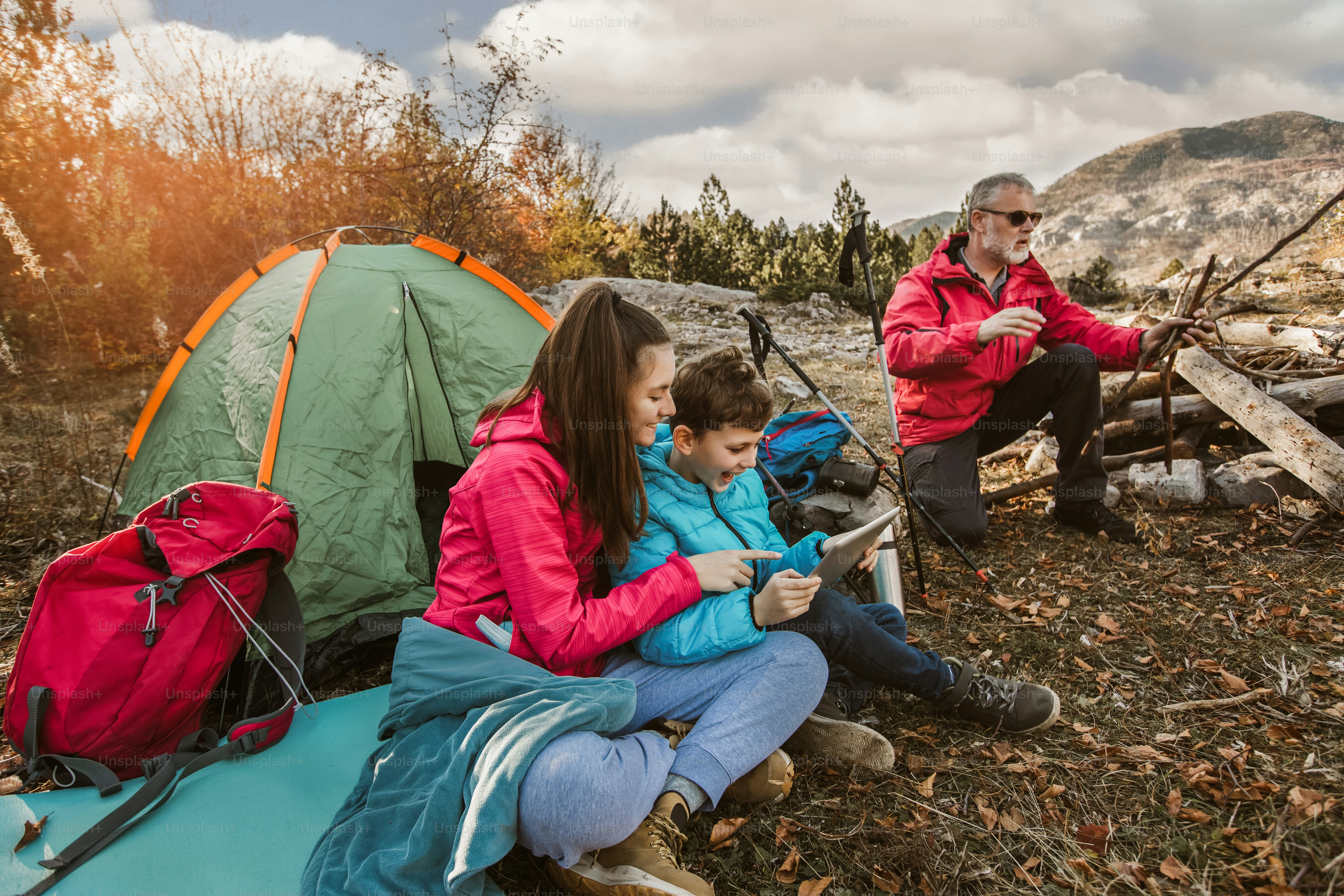 Happy family on a camping trip. Family doing camping in the forest ...