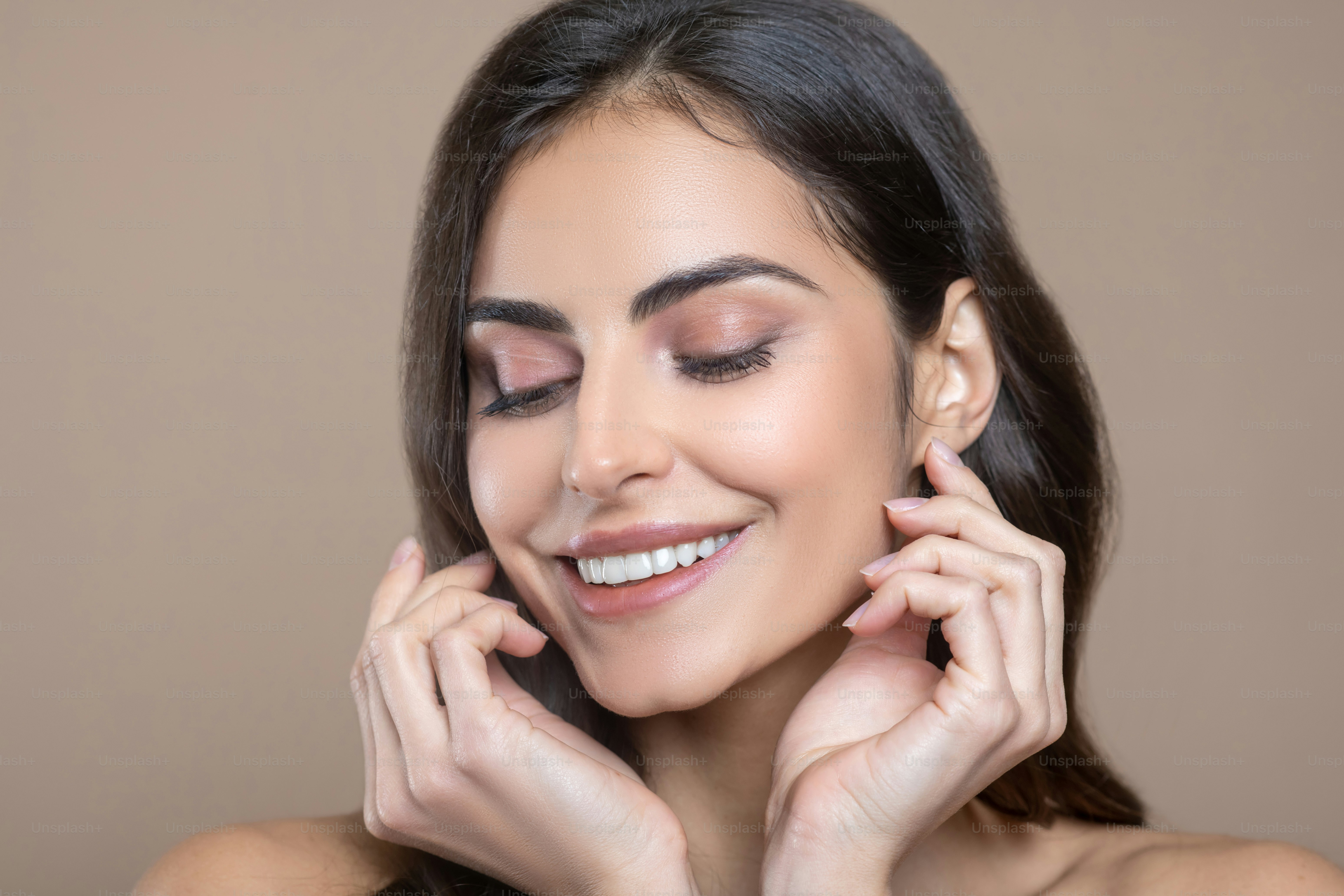 Pleasure, mood. Cute smiling pensive woman with long dark hair and ...