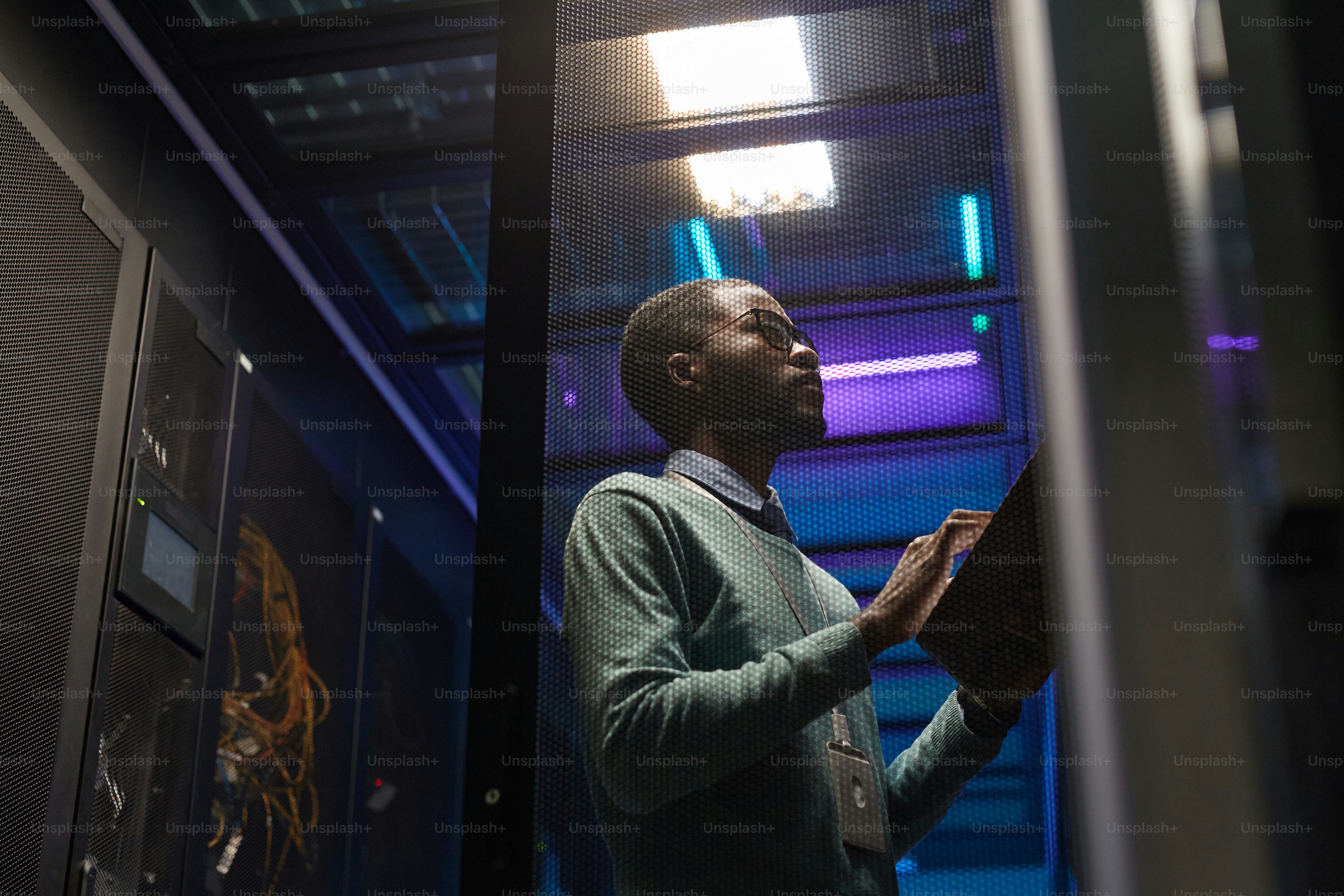Low angle portrait of African American data engineer working with ...