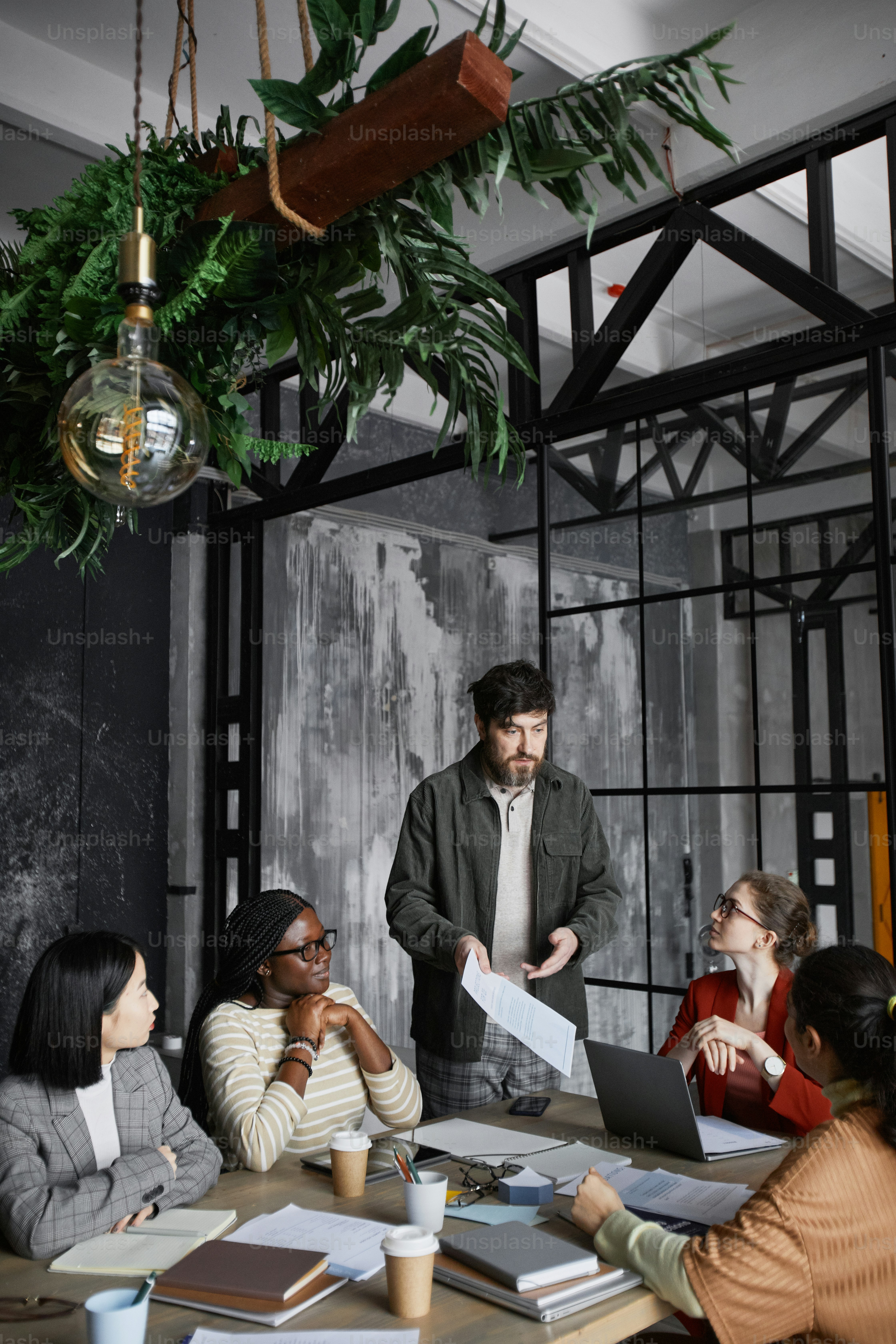 Vertical portrait of bearded businessman giving presentation to ...