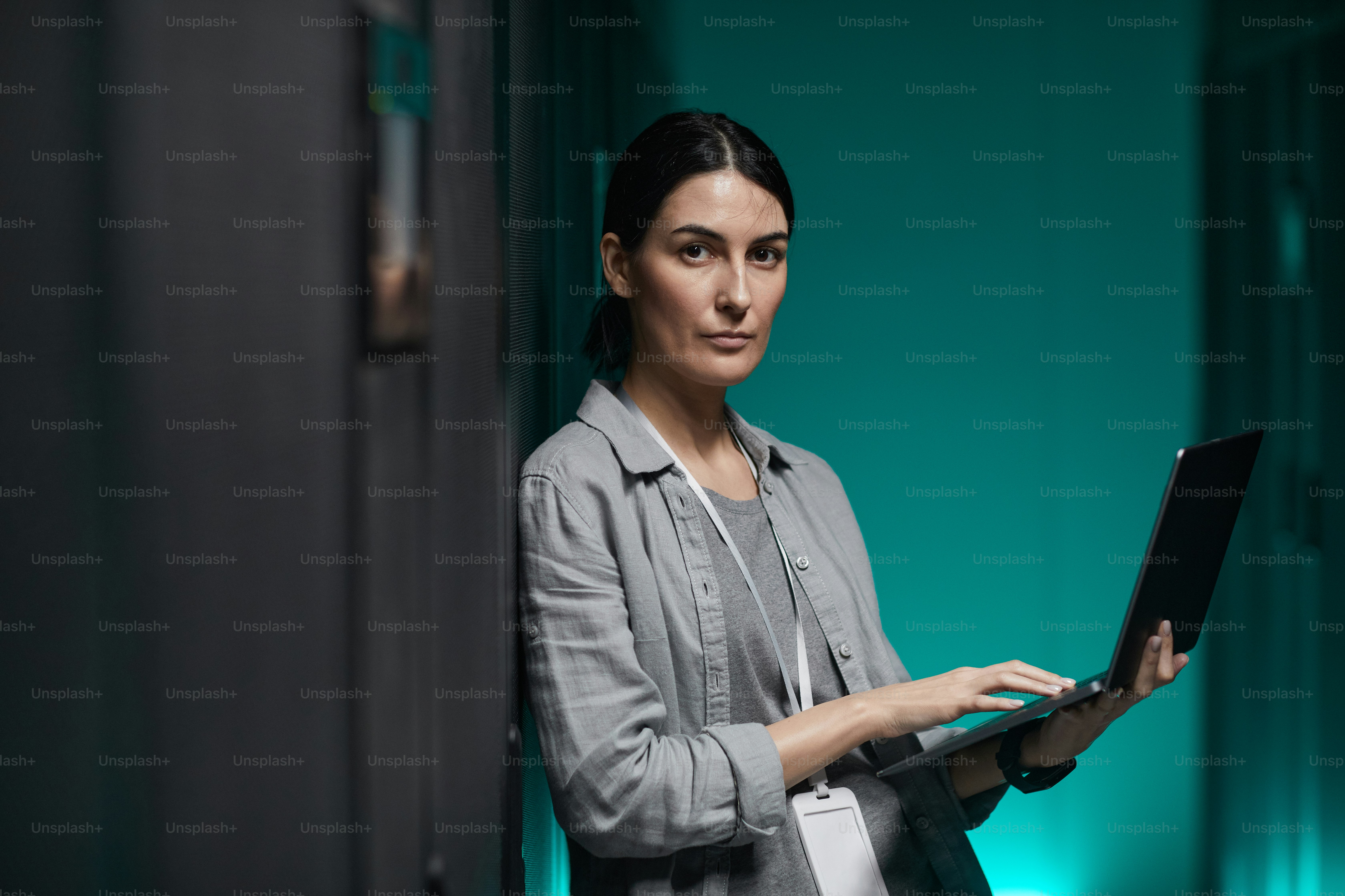 Close up of female network technician connecting cables in server ...