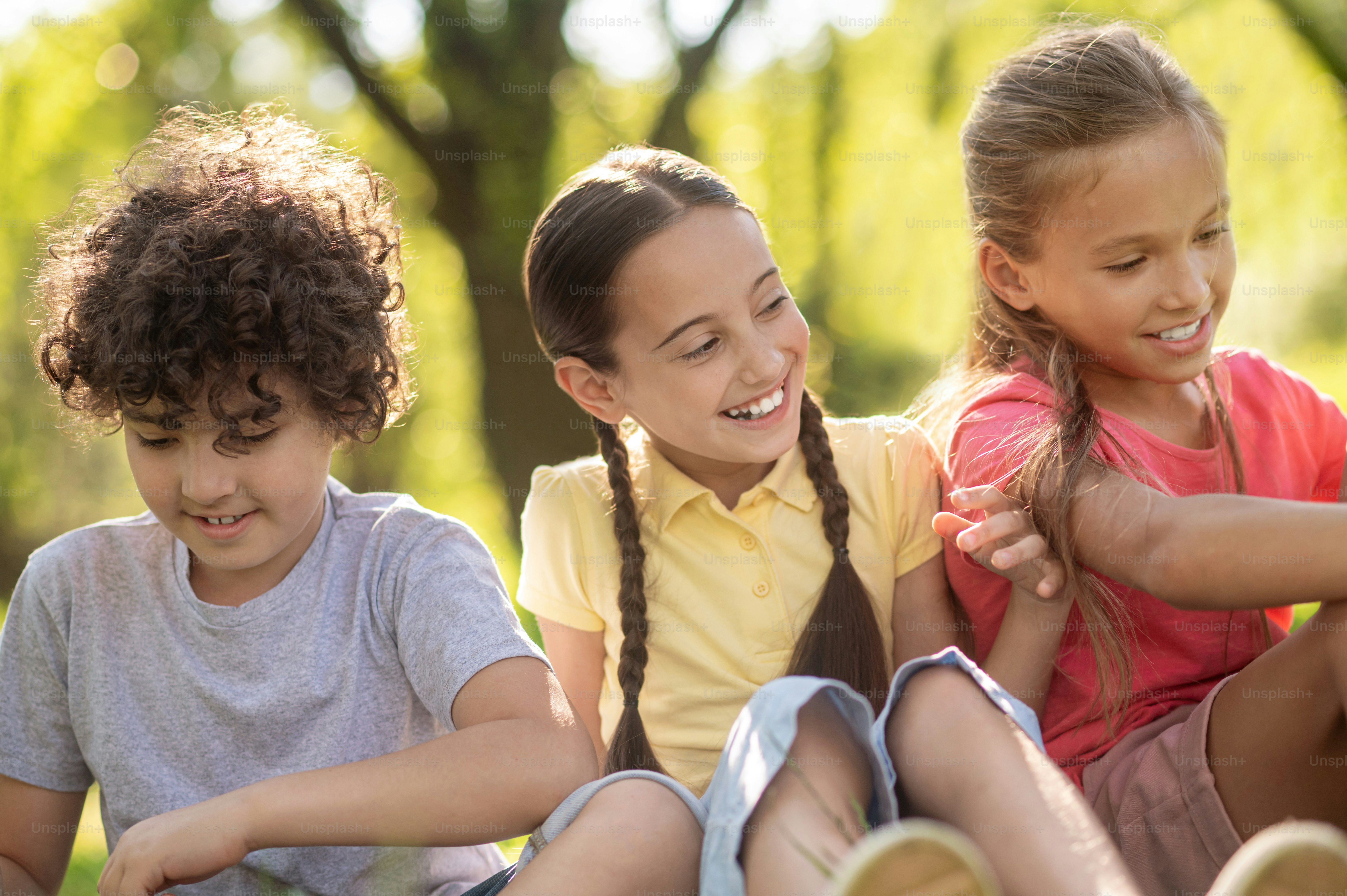 Liking. Smiling boys and girls of primary school age socializing ...
