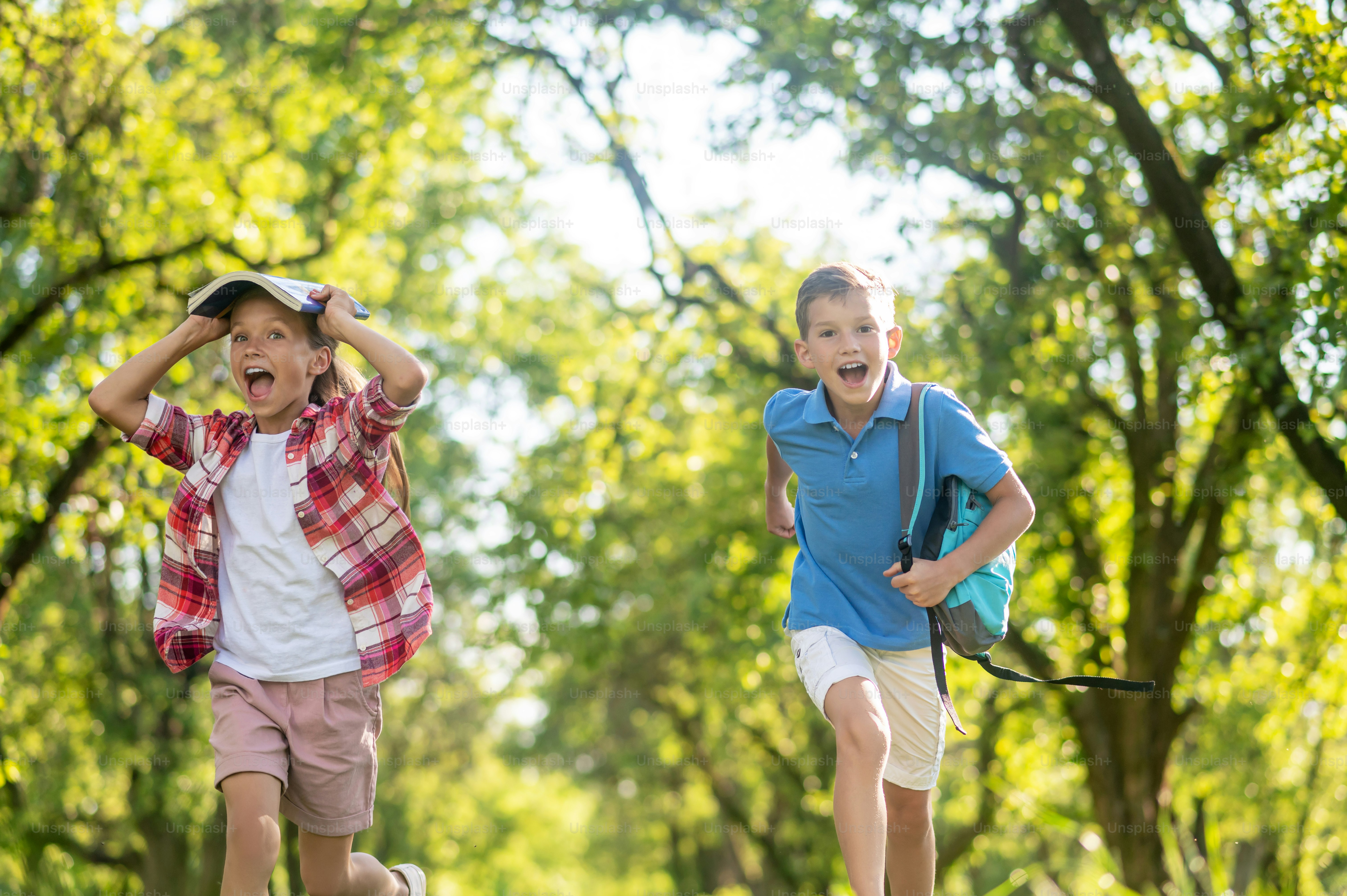 Rush. Hurrying energetic cheerful girl and primary school age boy ...