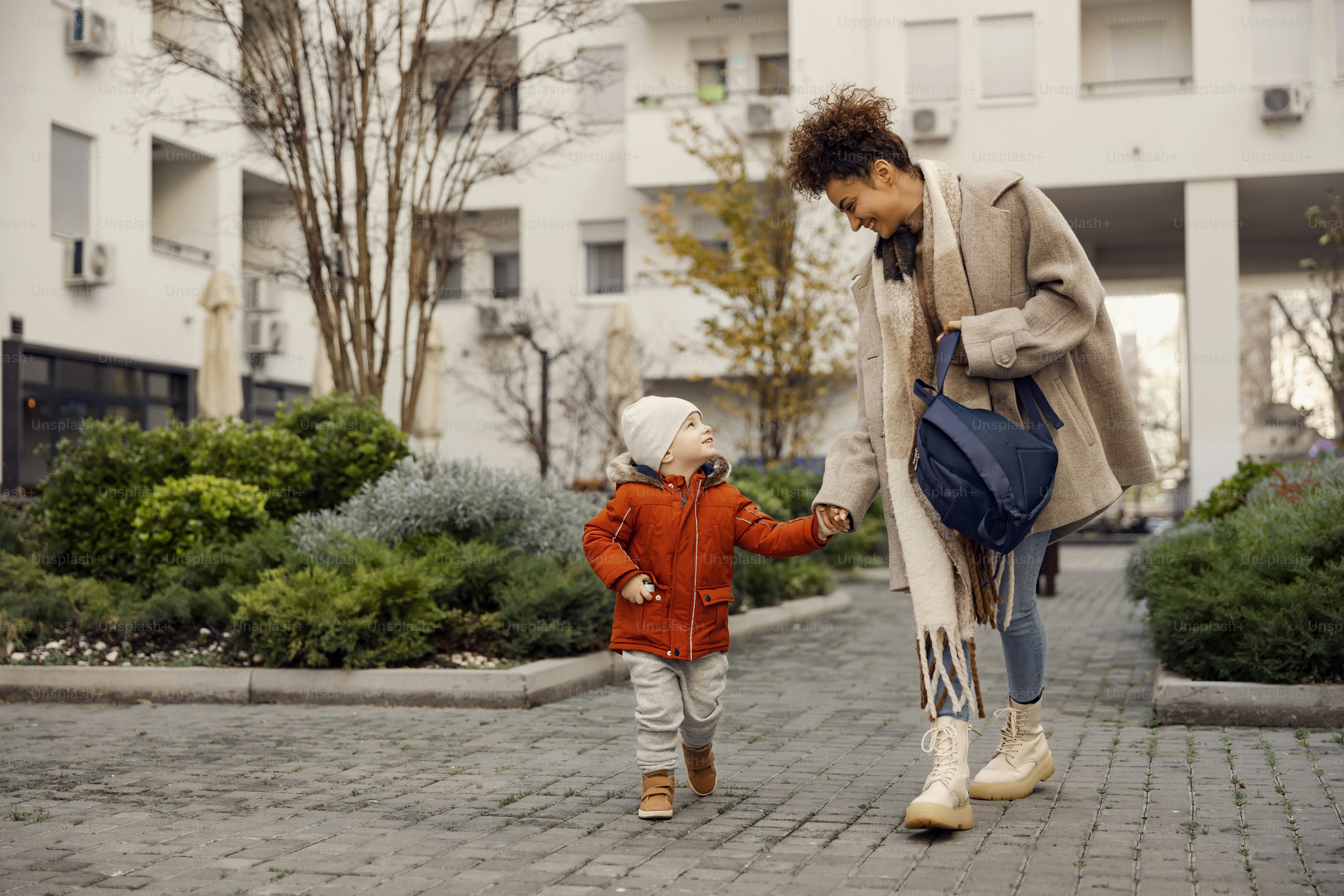 Caregiver taking kindergarten boy to kindergarten. The caregiver ...