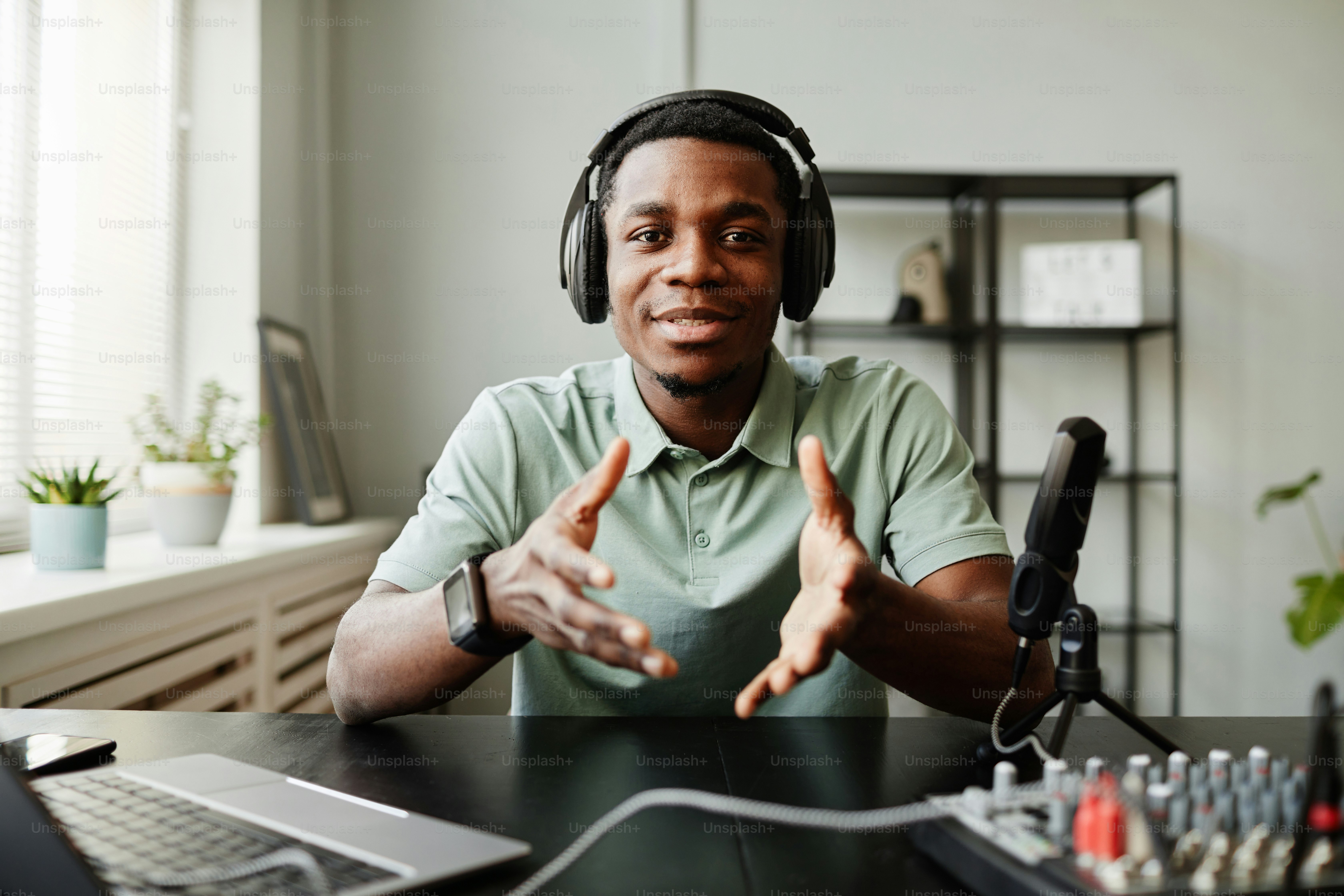 Portrait of African-American man speaking to camera while recording ...