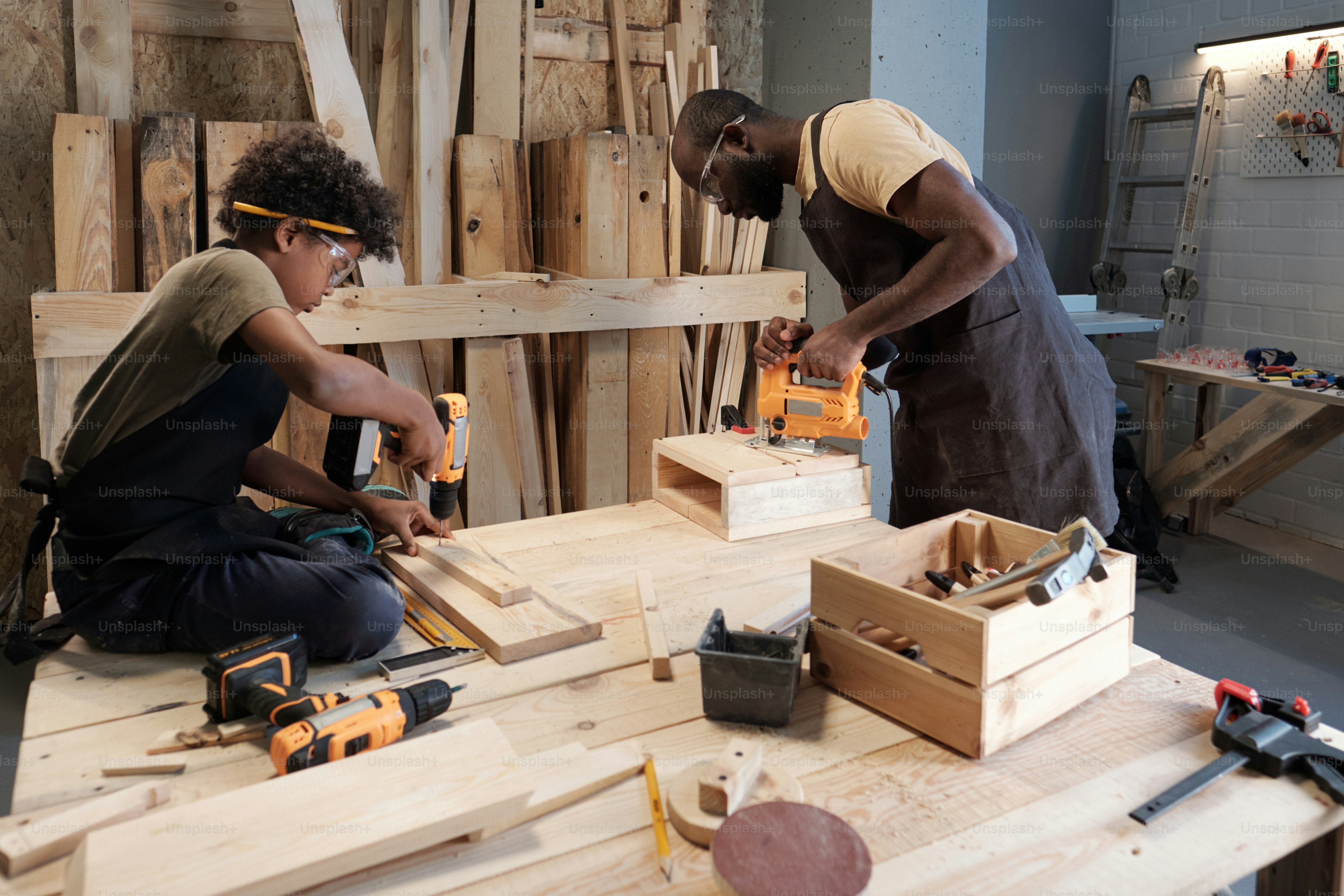 Side view portrait of African-American father and son working in ...