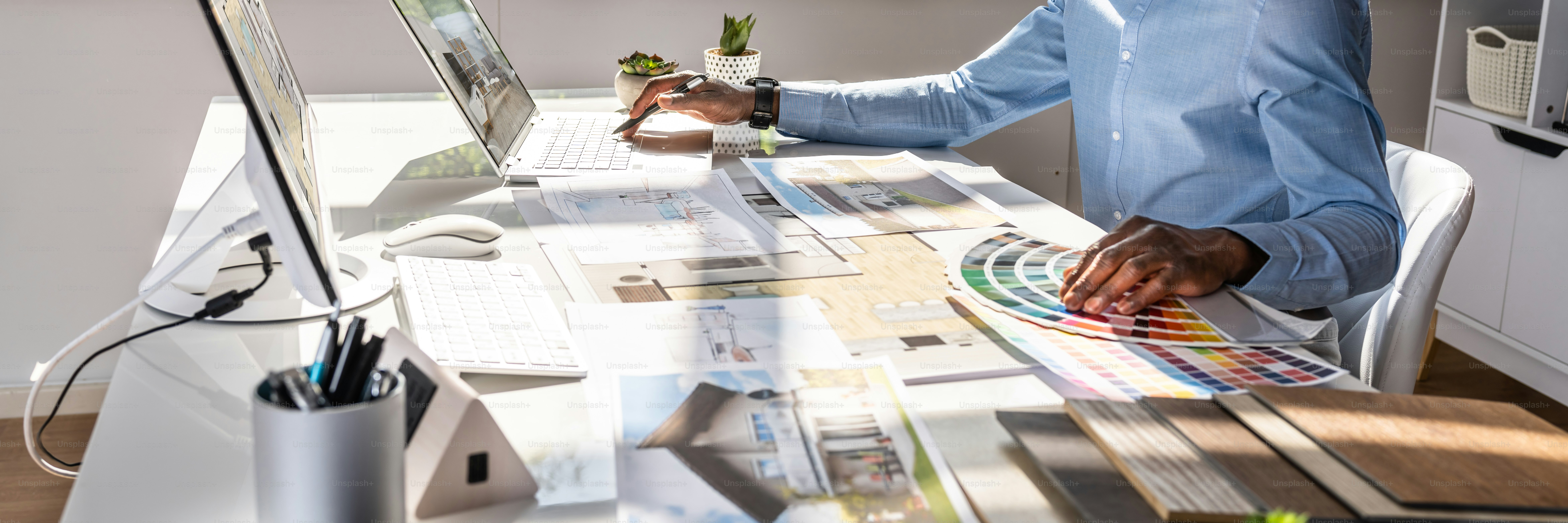 Side View Of Real Estate Designer Working On Computer In Office photo ...
