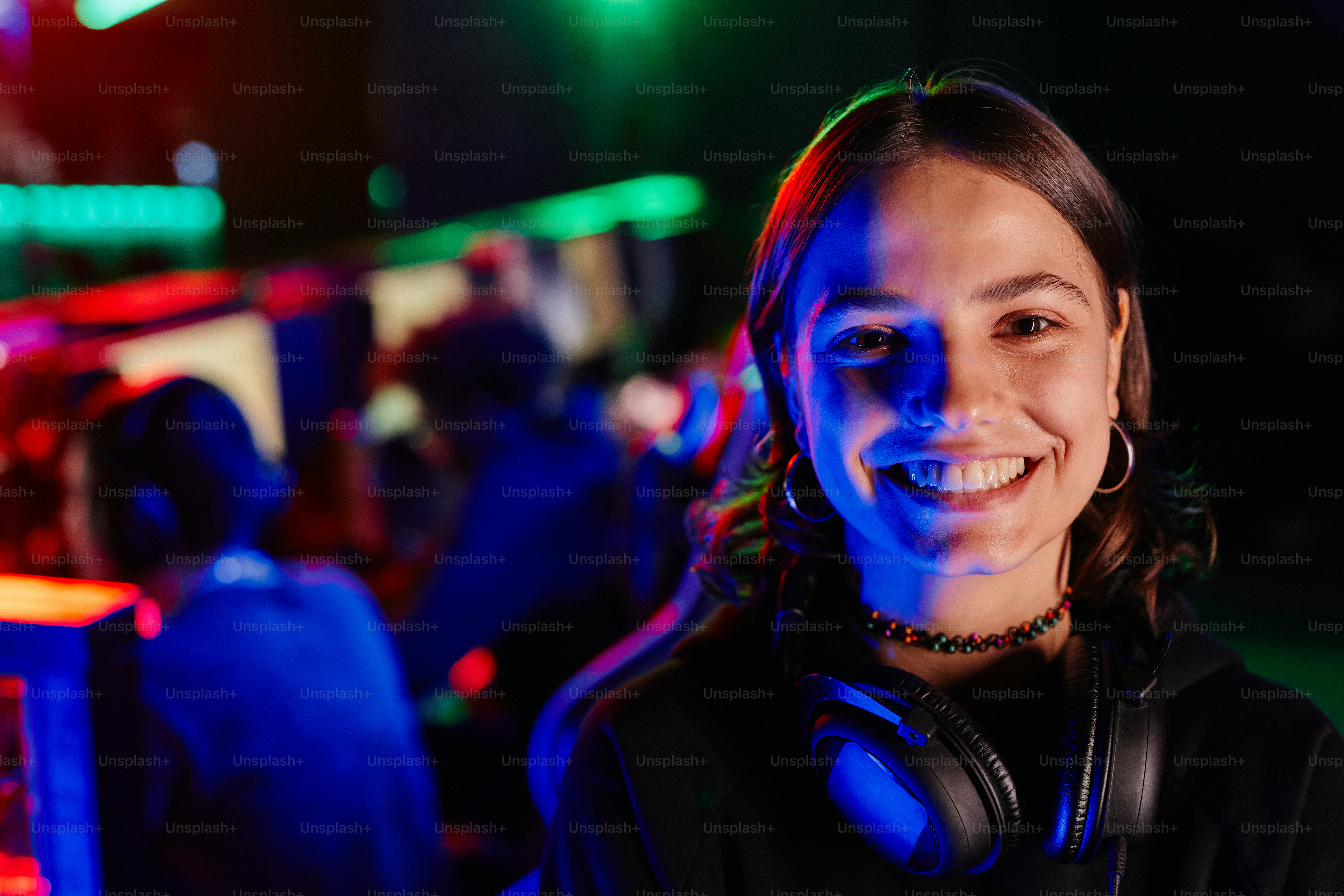 Close up portrait of young woman on e-sports team smiling at camera ...