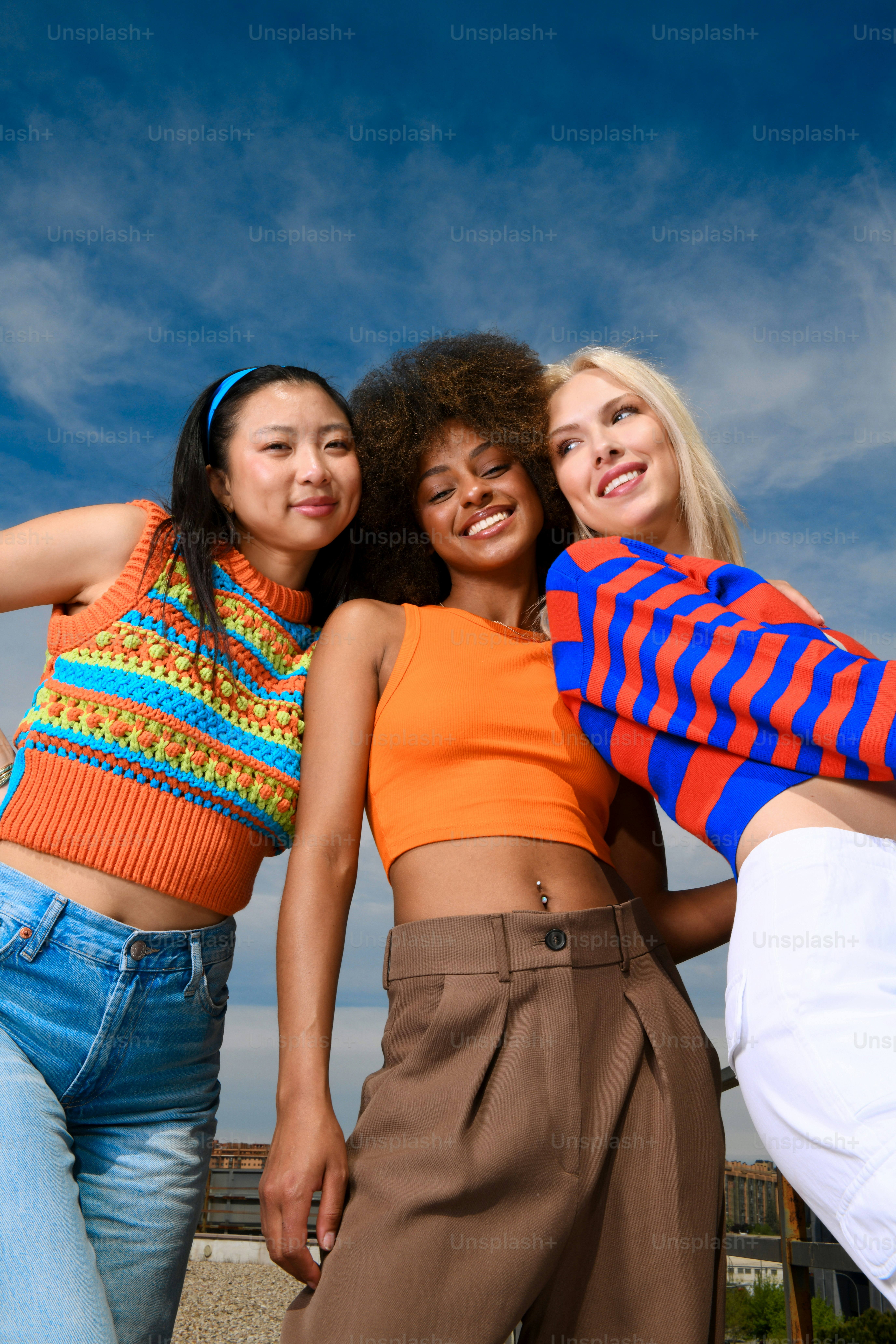 A group of three women standing next to each other photo – Fashion ...